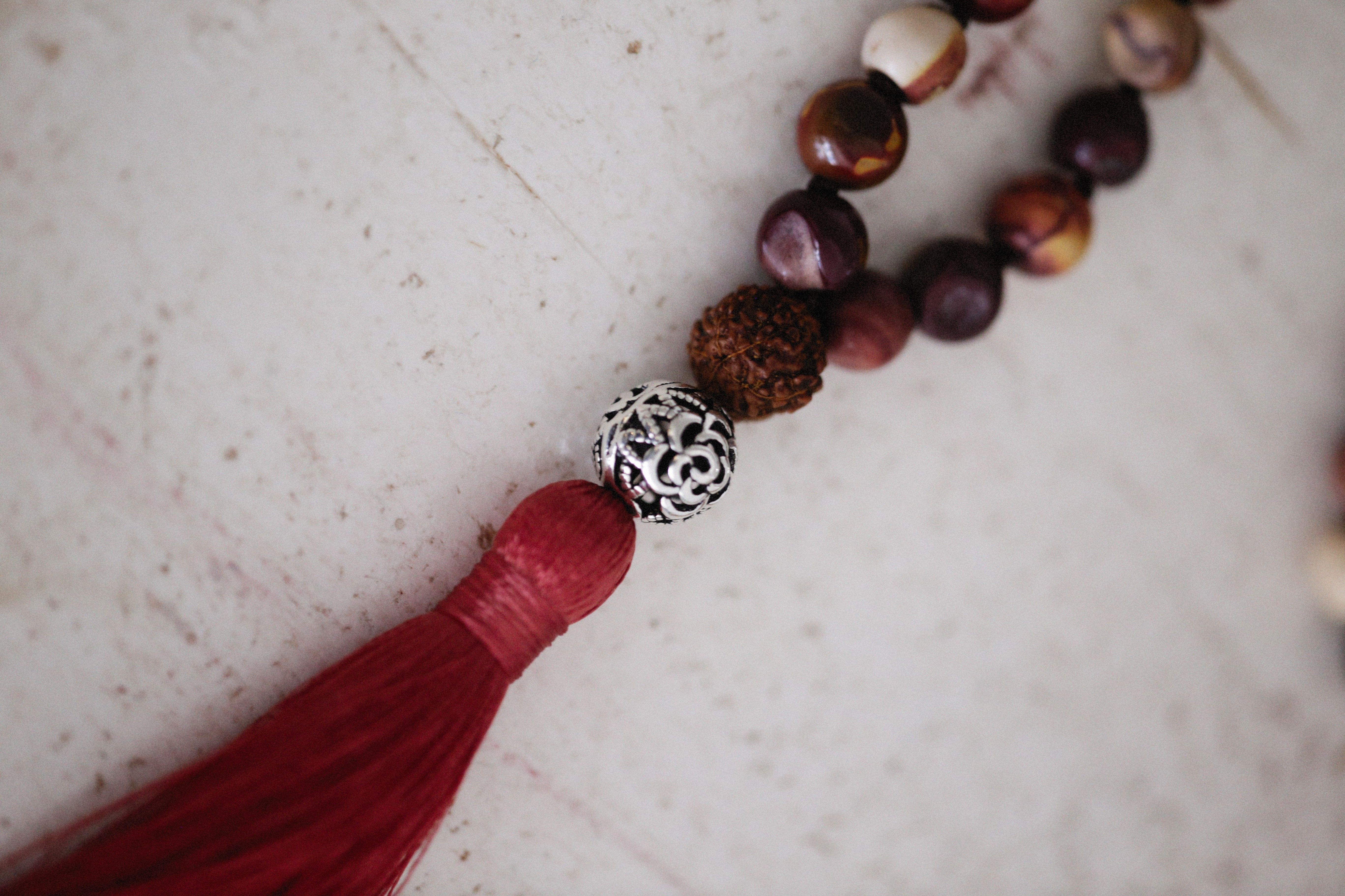 Close Up Photo of Beaded Accessories on Gray Surface · Free Stock Photo