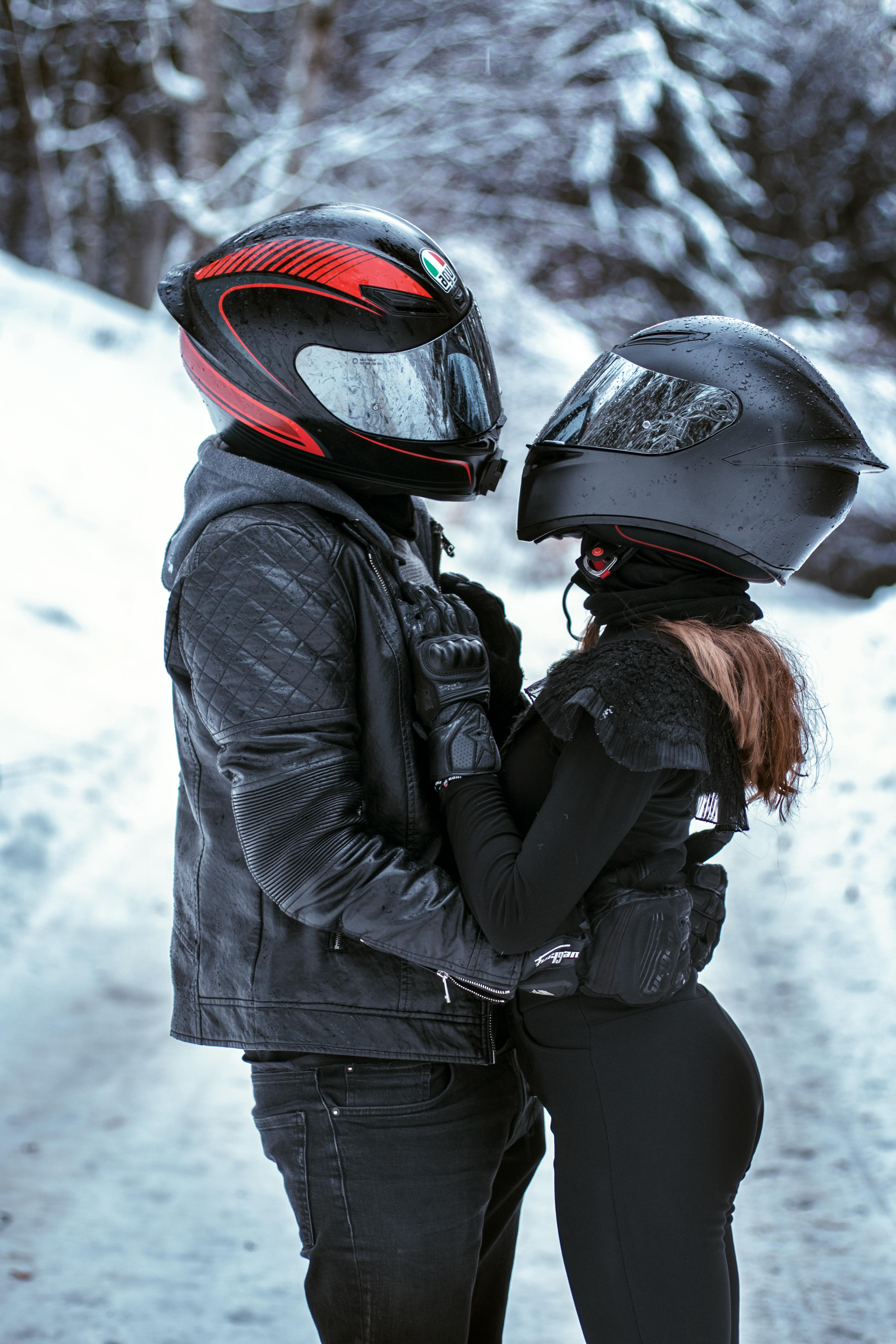 A Couple Wearing Helmets Hugging Each Other · Free Stock Photo