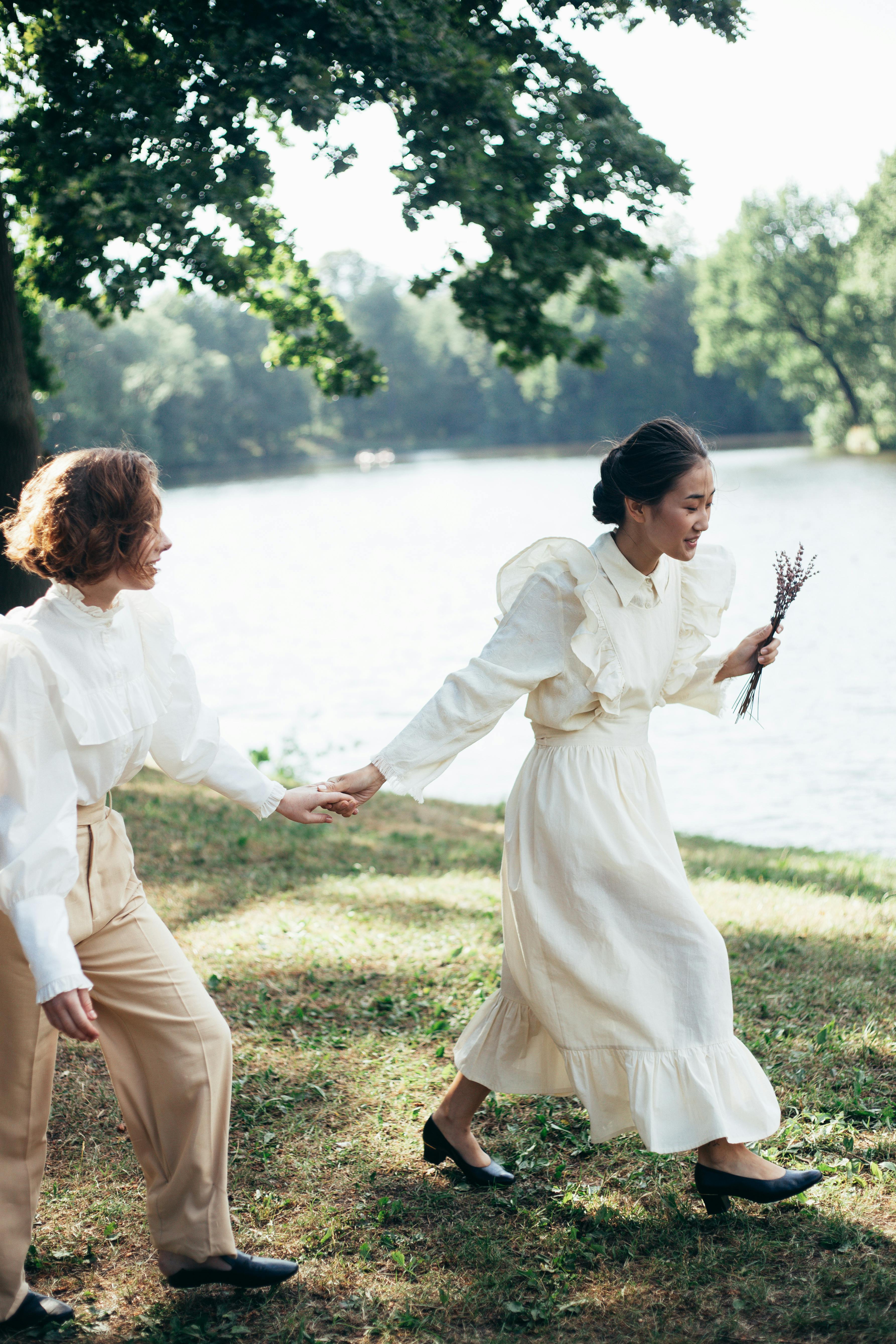 Women Holding Hands While Walking · Free Stock Photo