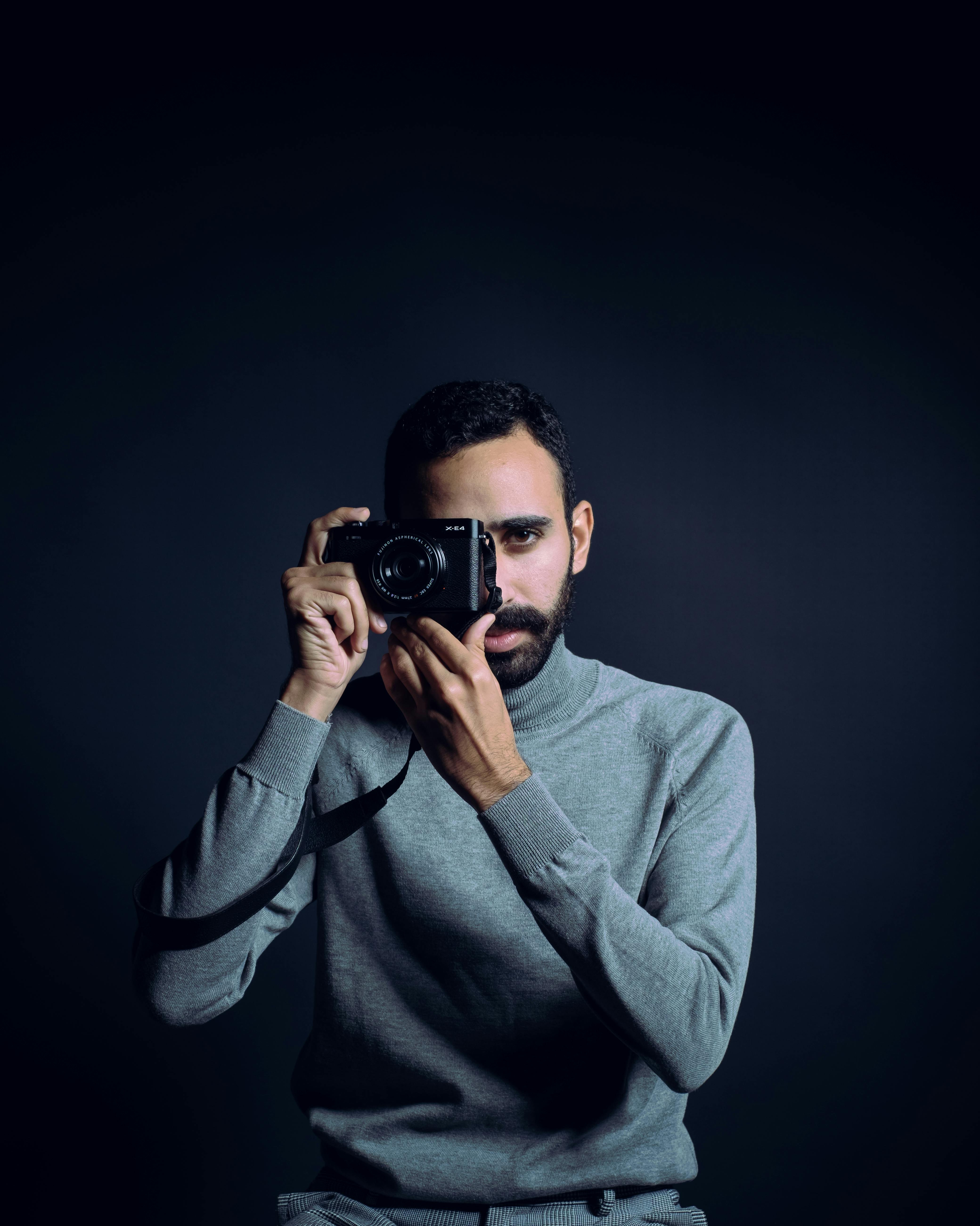 Grayscale Portrait Photo of Man Wearing Holding a Camera · Free Stock Photo