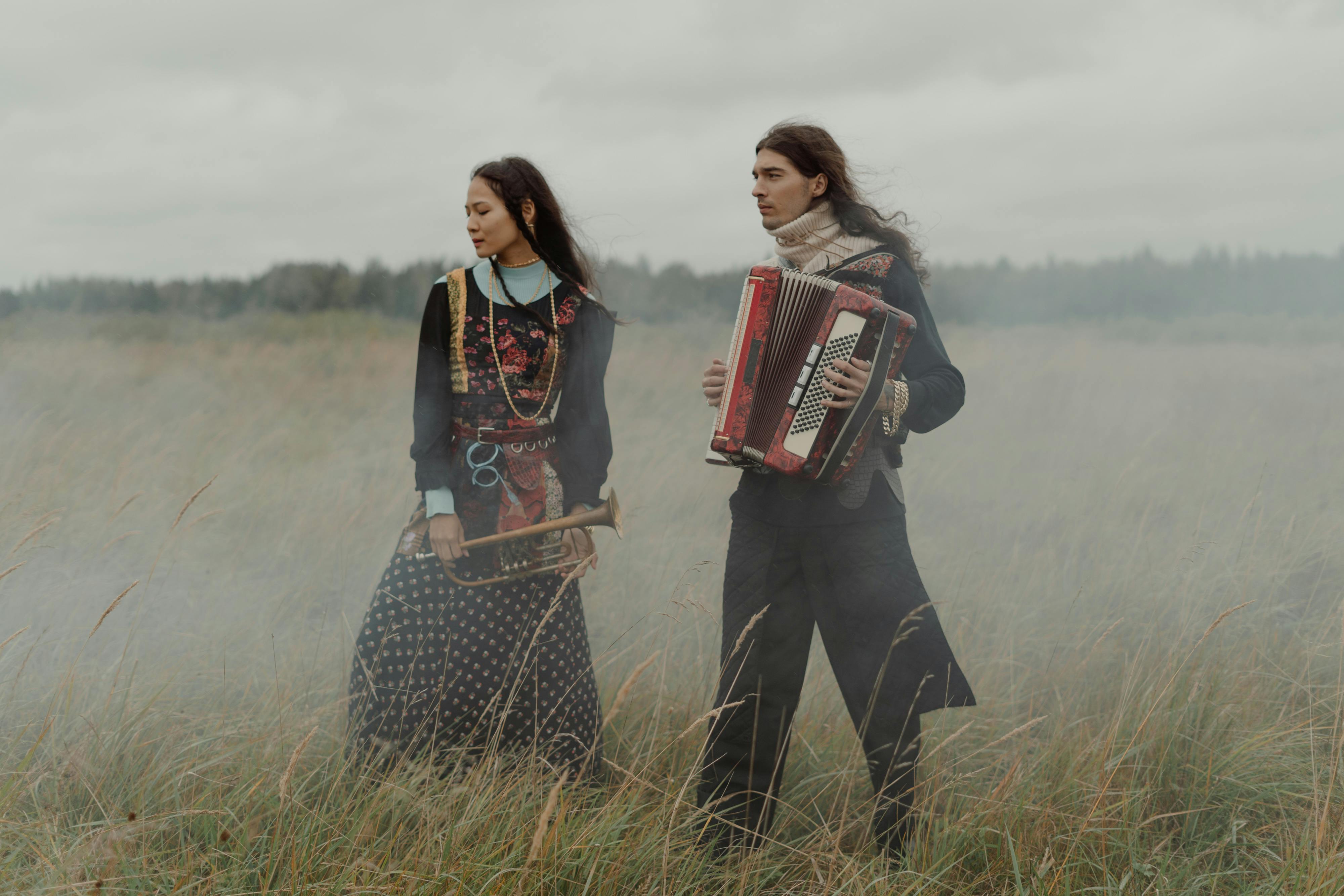 Gypsies with Musical Instruments at a Grass Field · Free Stock Photo