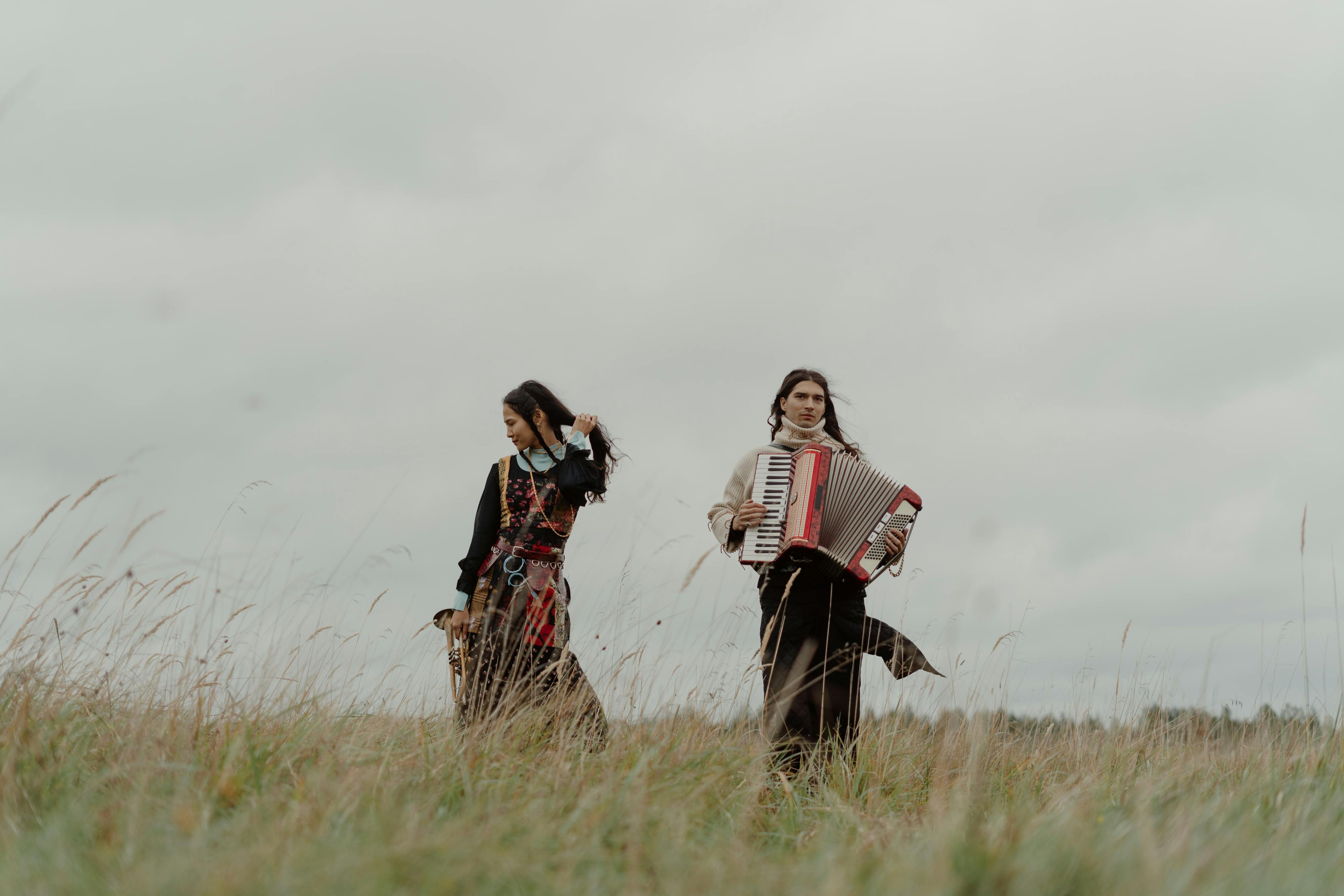 Gypsies with Musical Instruments at a Grass Field · Free Stock Photo