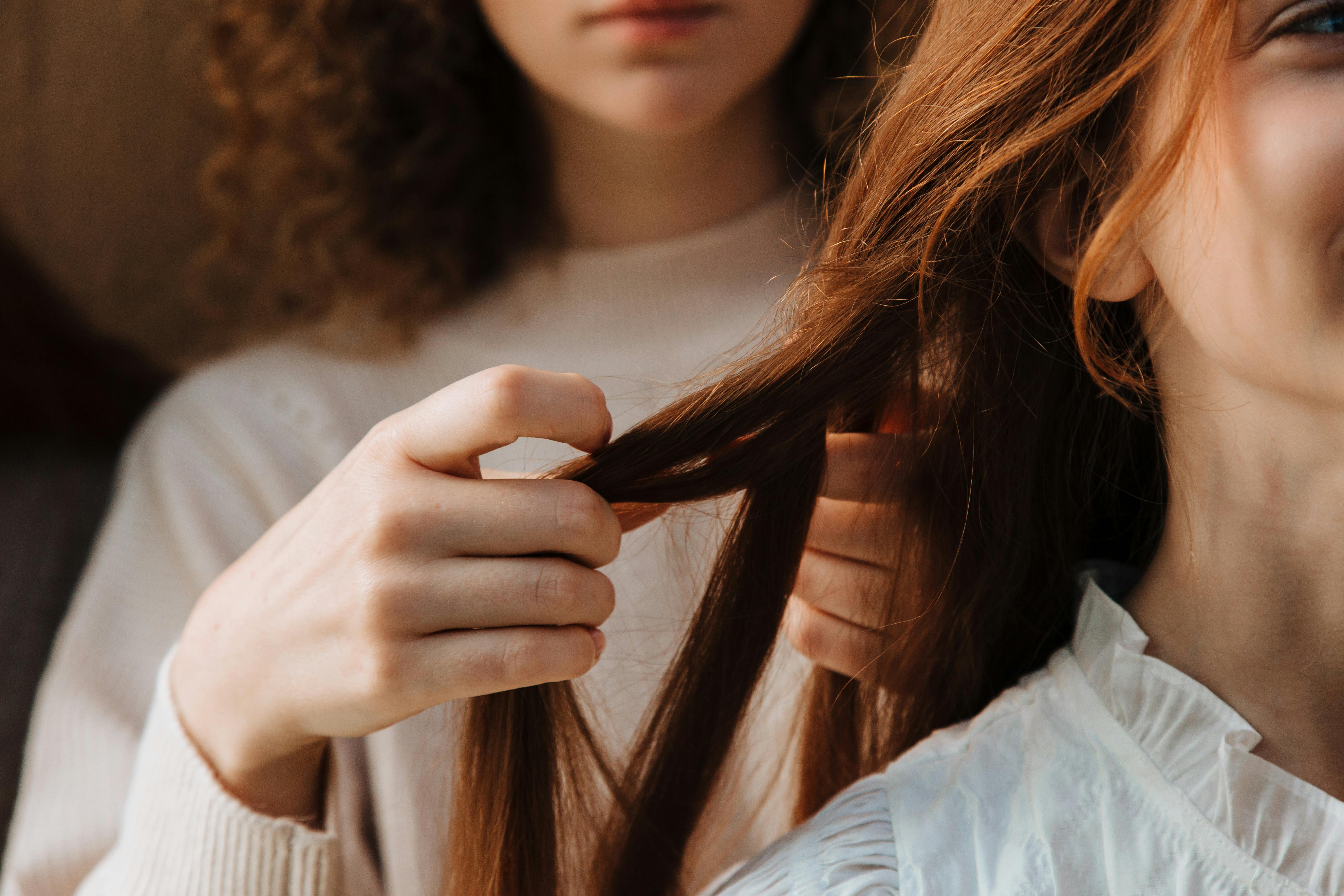 Close-up of Woman Braiding Friends Hair · Free Stock Photo