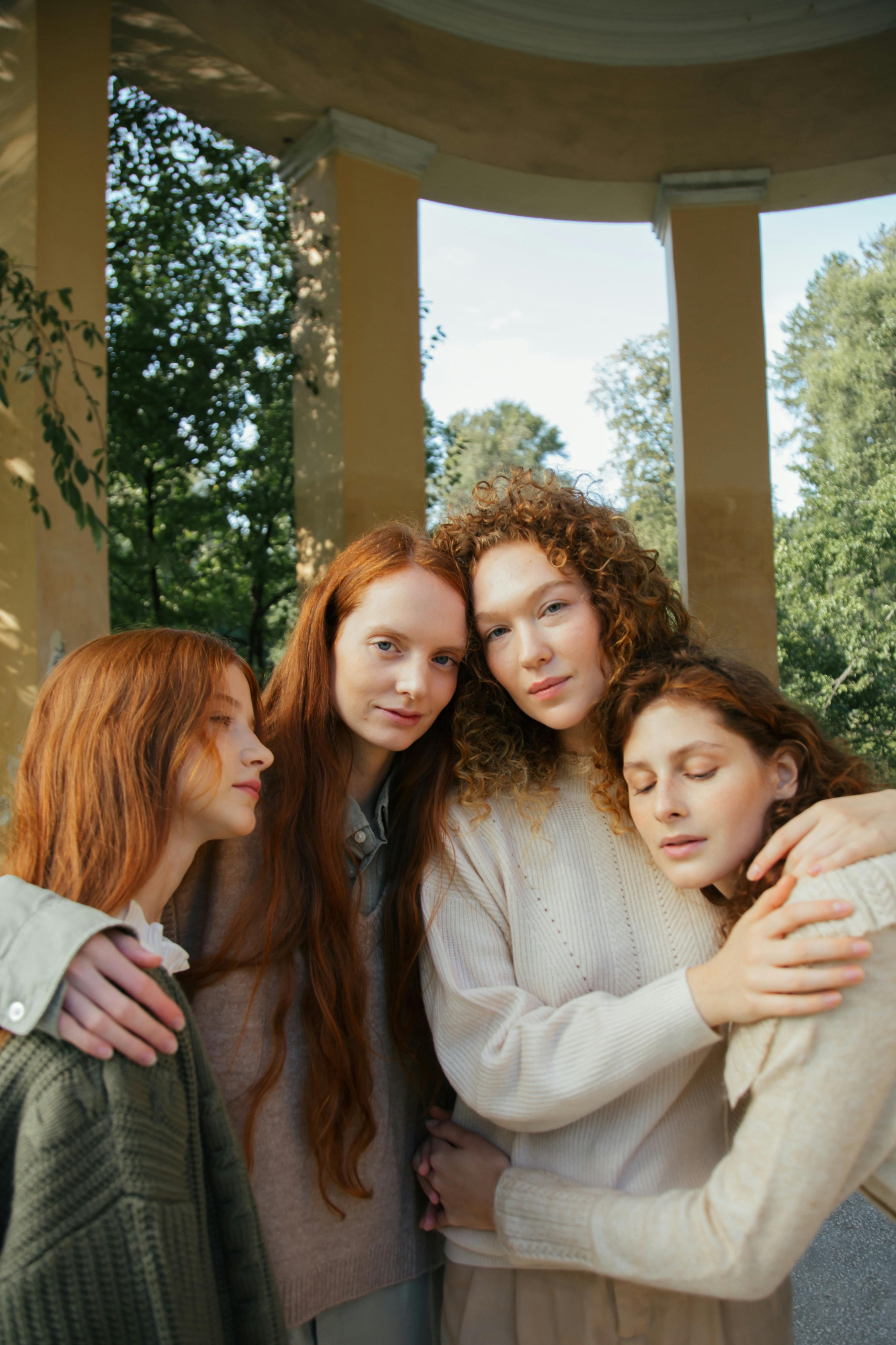 Portrait of Four Female Friends Embracing in Park · Free Stock Photo