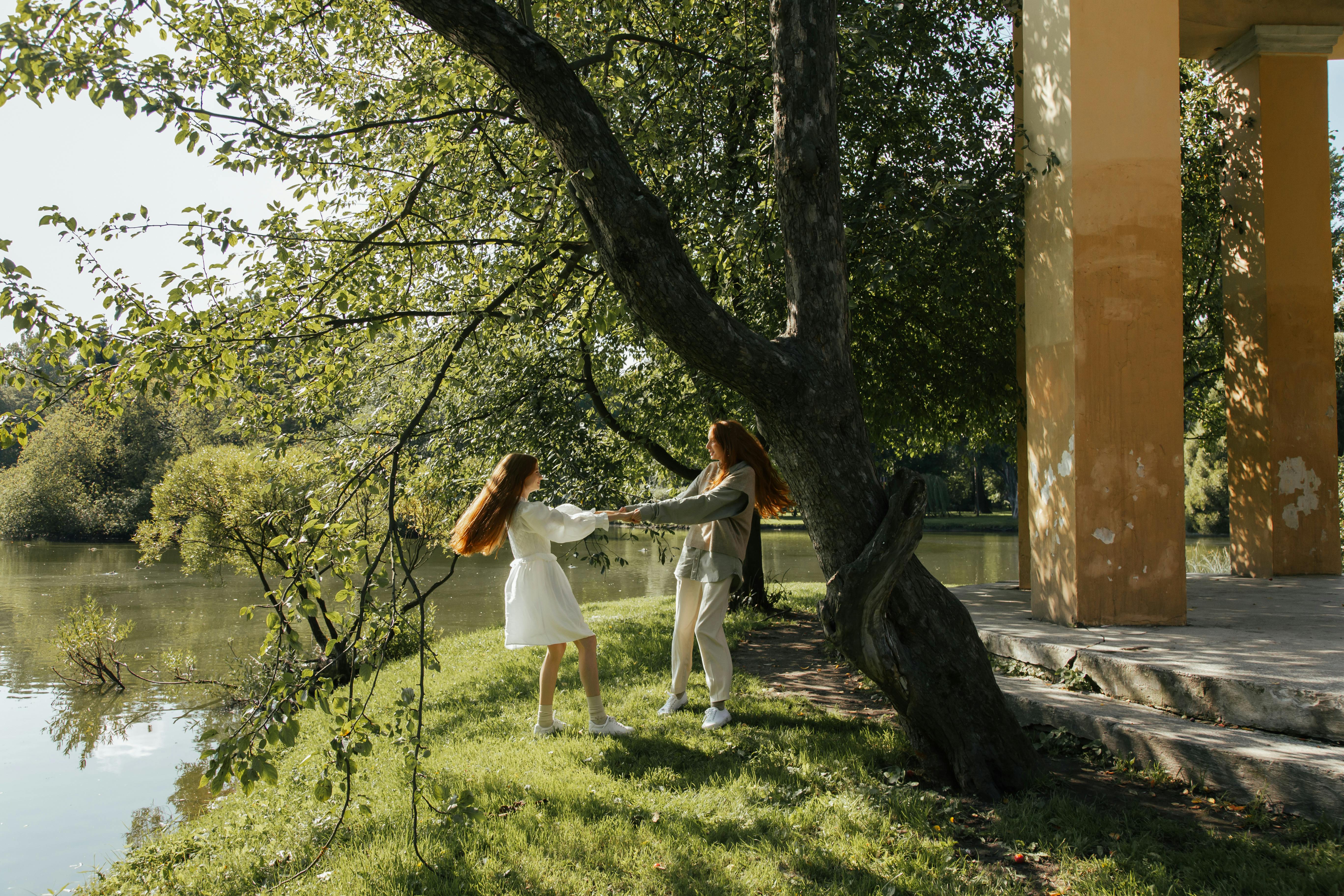 Women Dancing under Tree in Park · Free Stock Photo