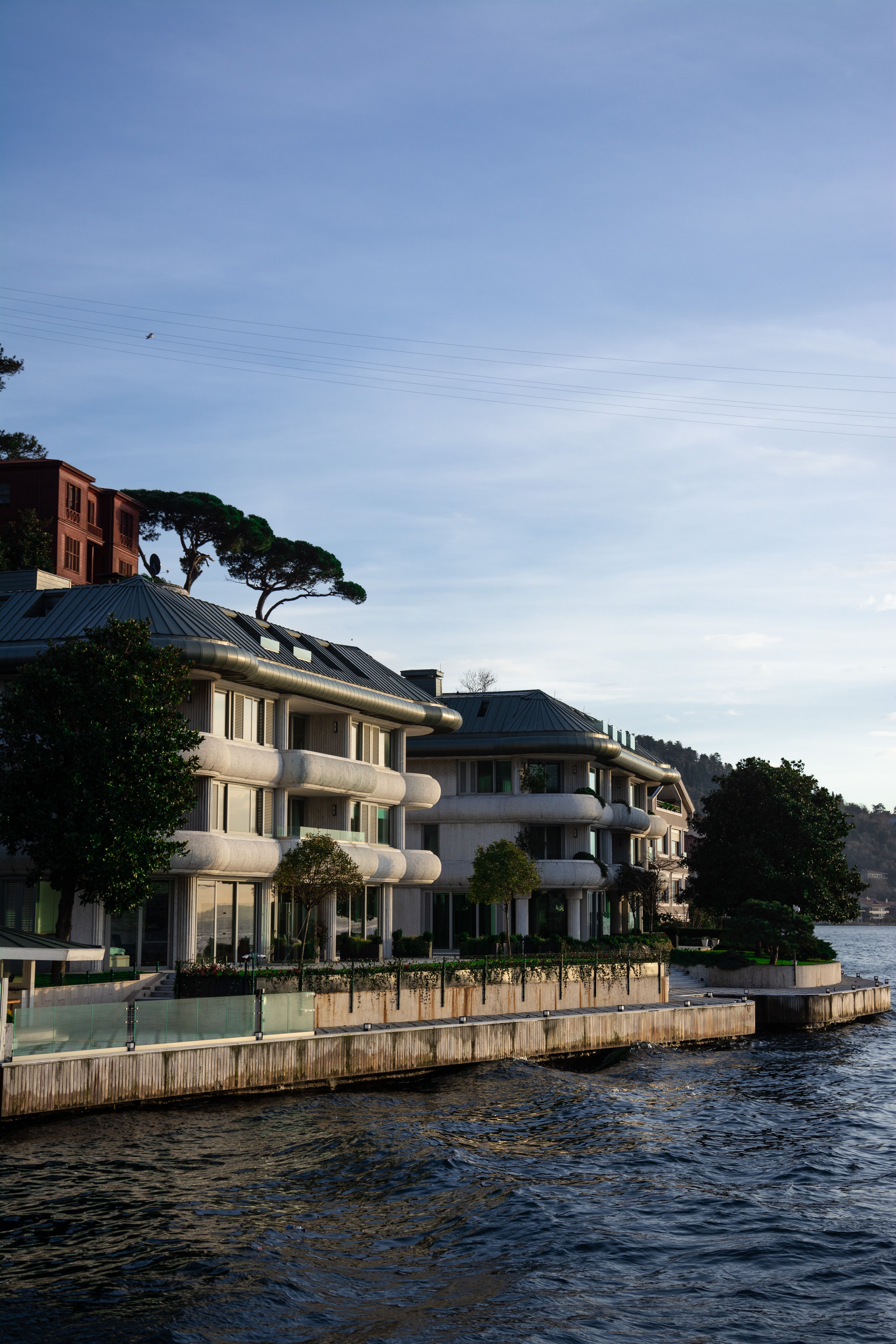 White Concrete Buildings Near Body of Water · Free Stock Photo