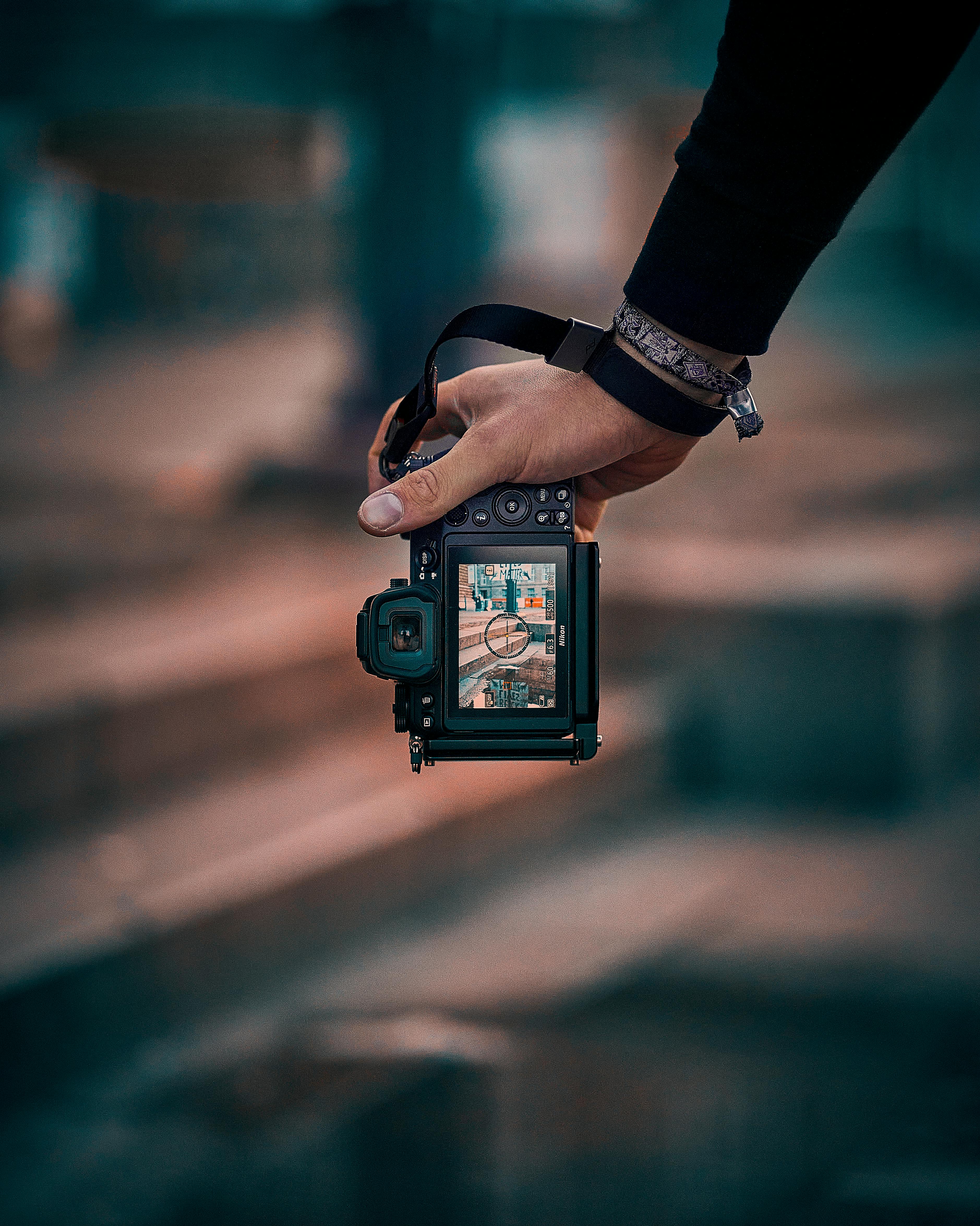 Close-Up Shot of a Person Holding a Camera · Free Stock Photo