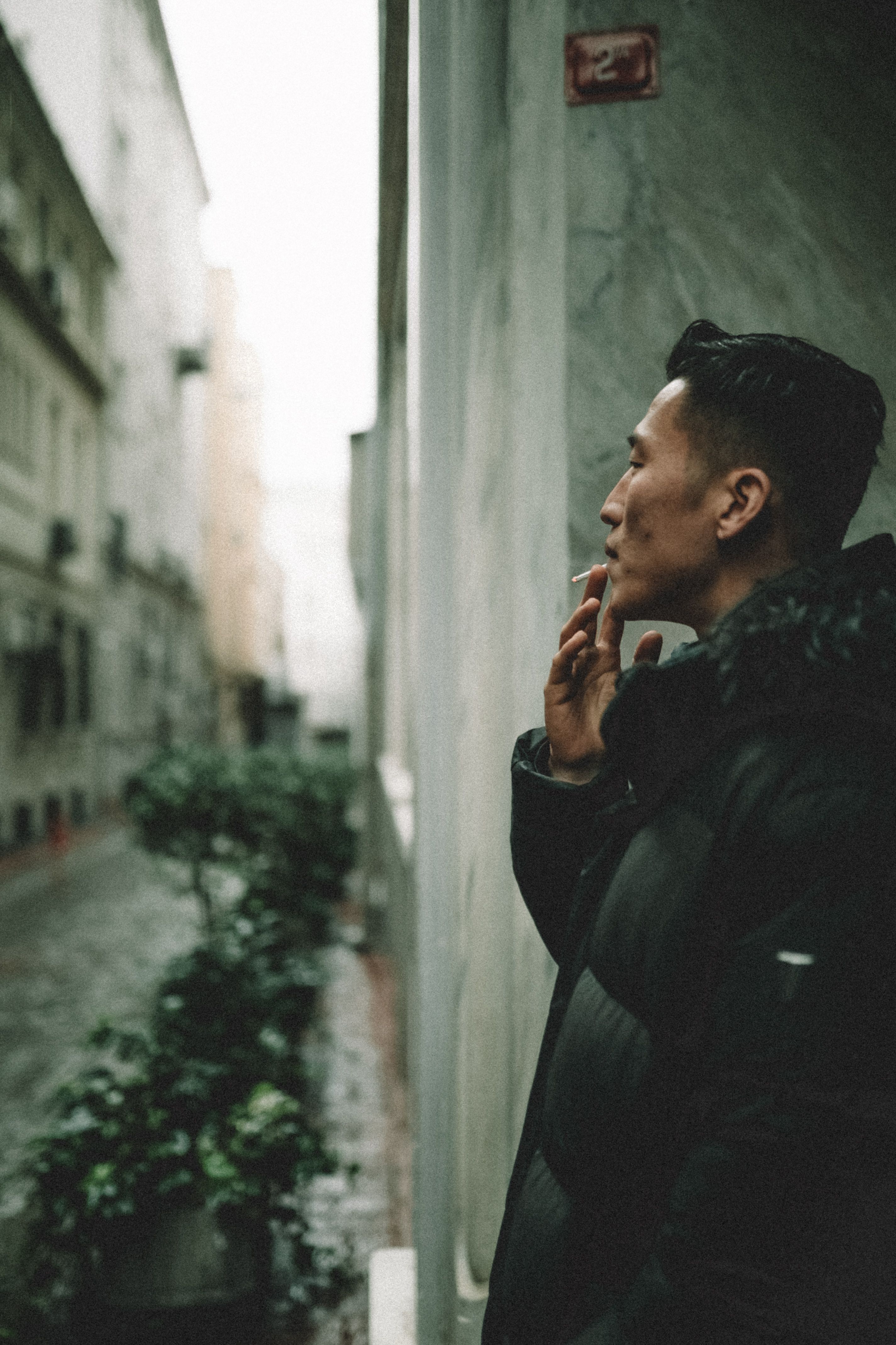 Man Standing Outdoors and Smoking Cigarette · Free Stock Photo