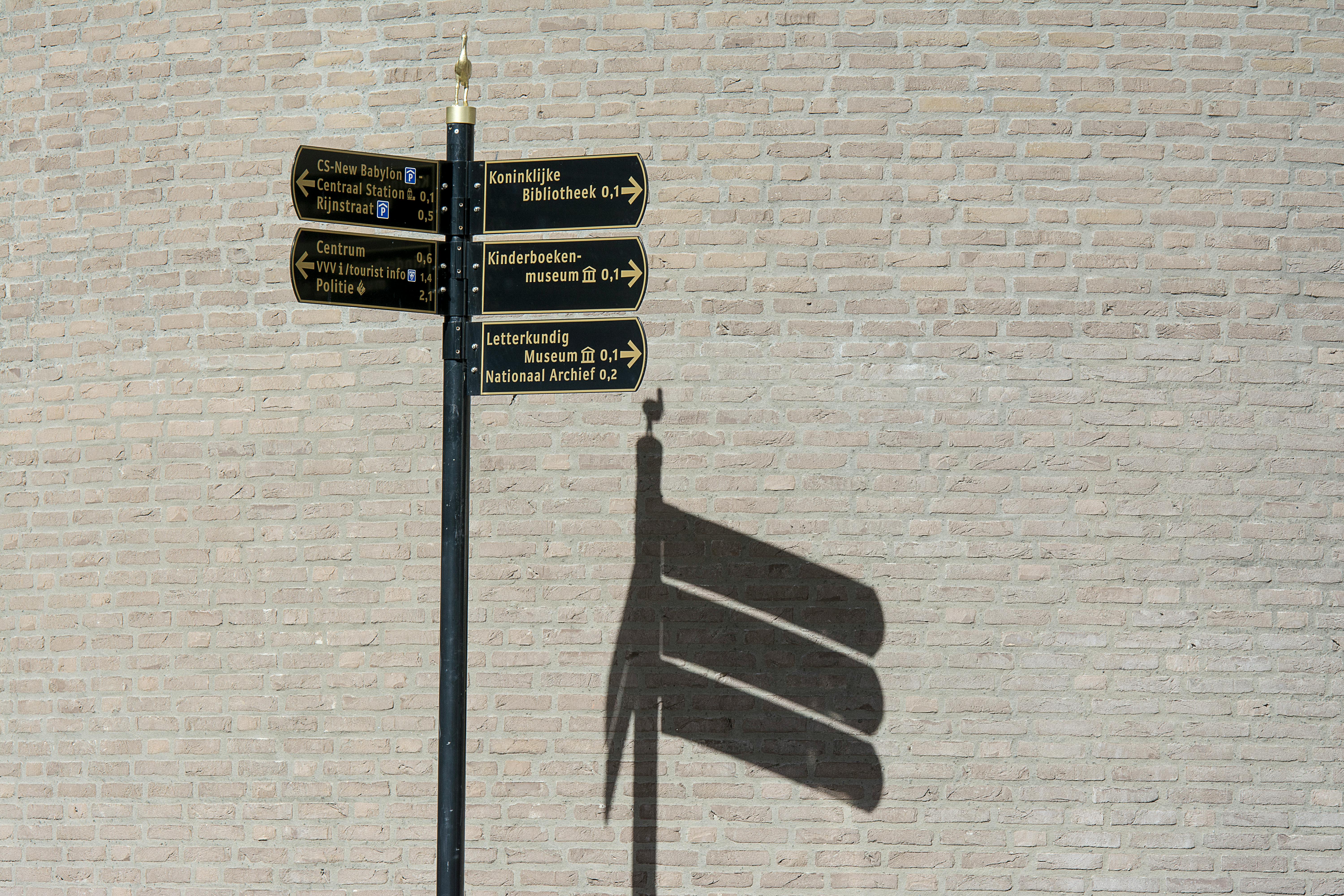 Black and Gold Road Sign on the Street · Free Stock Photo