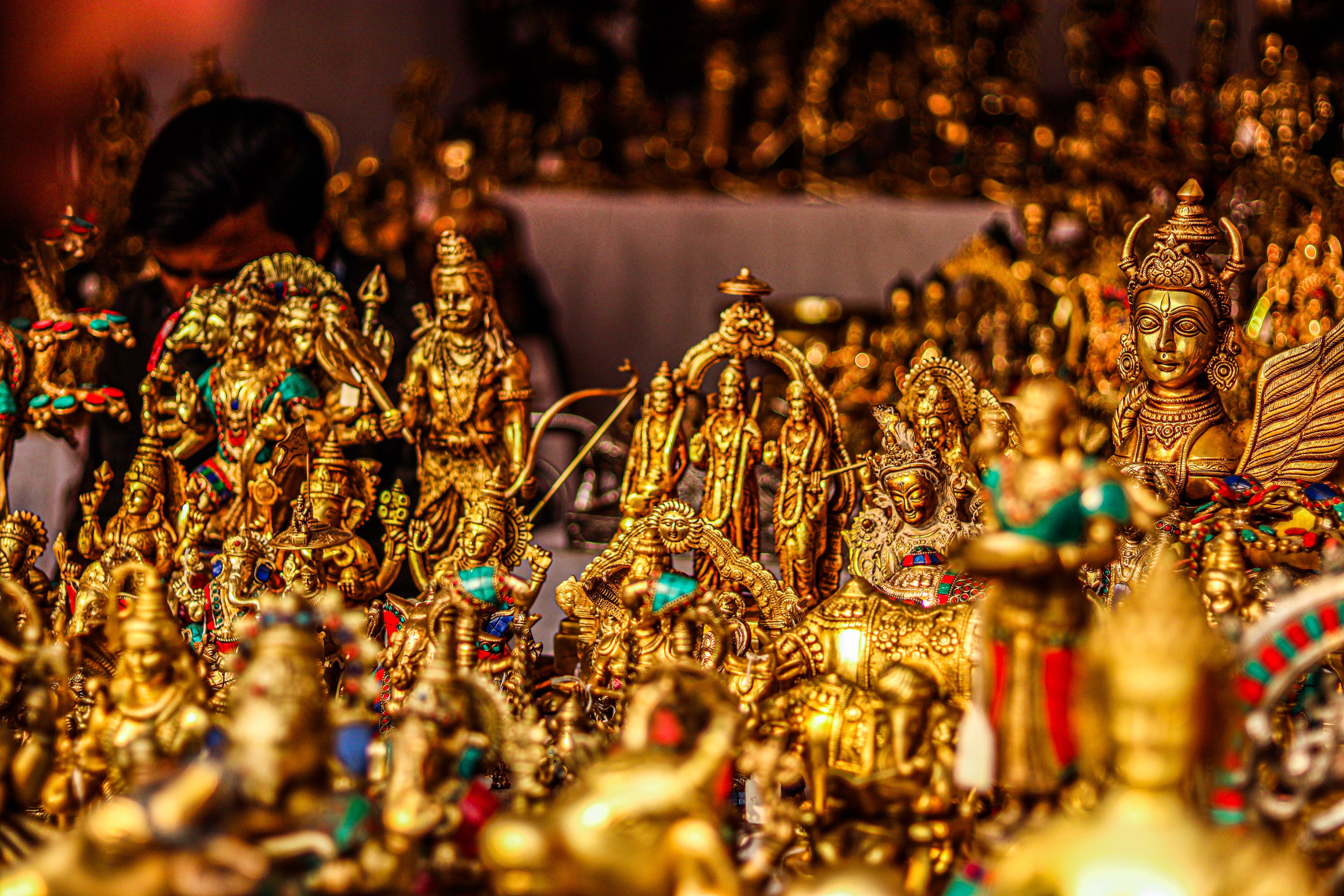 Golden Religious Figurines on Table · Free Stock Photo
