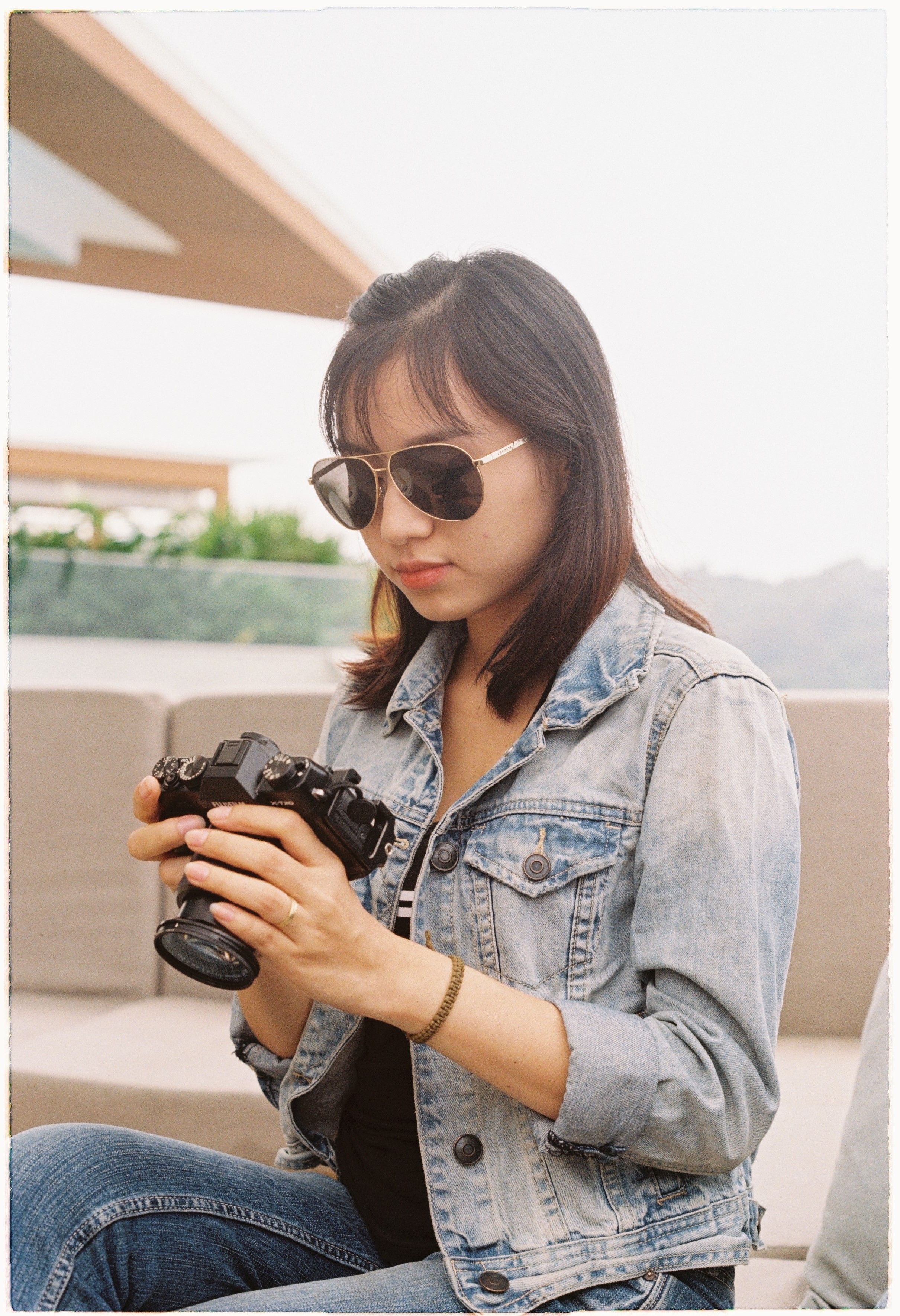 A Photographer in Denim Jeans and Jacket · Free Stock Photo