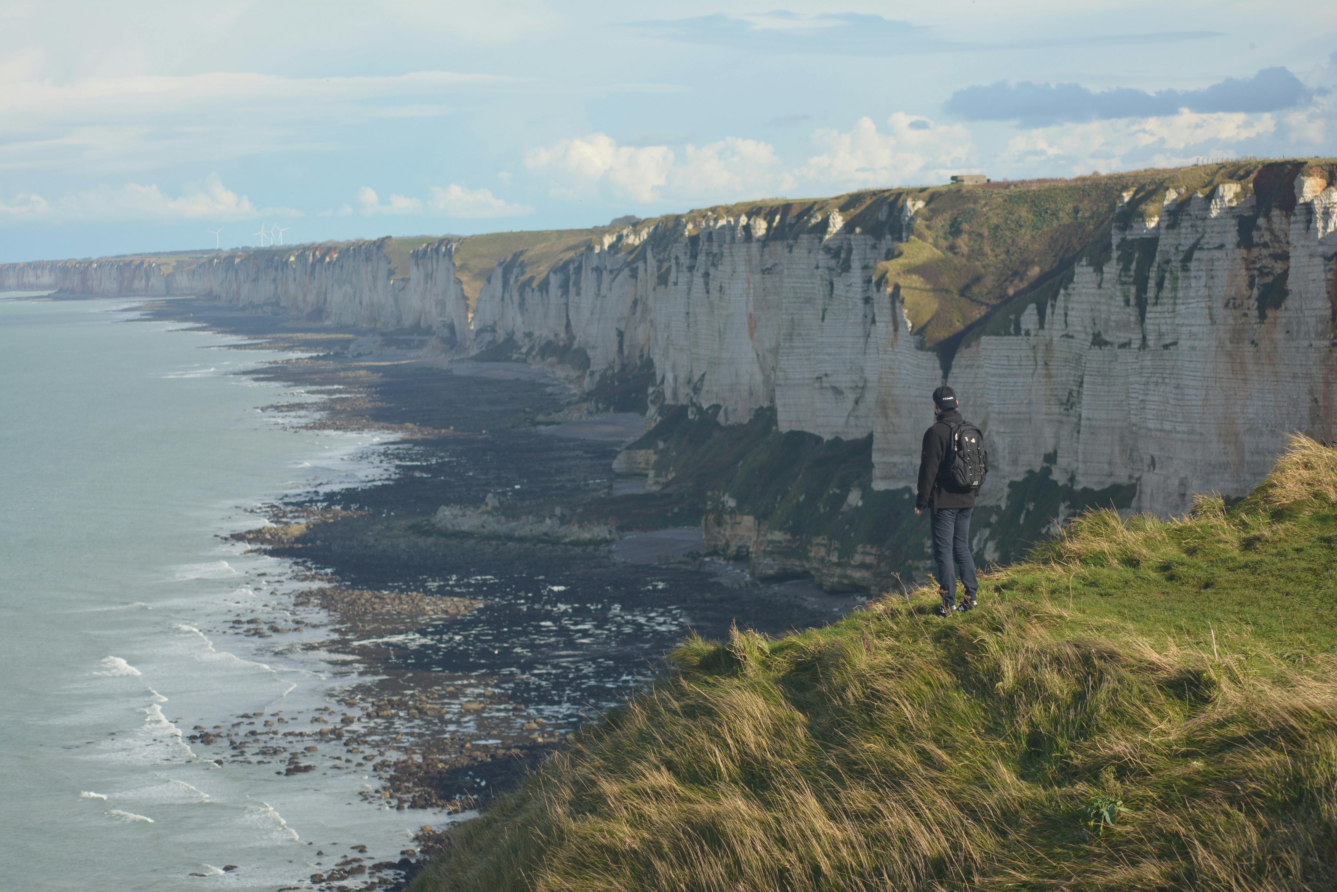 Grayscale Photo of Woman Standing on the Cliff · Free Stock Photo