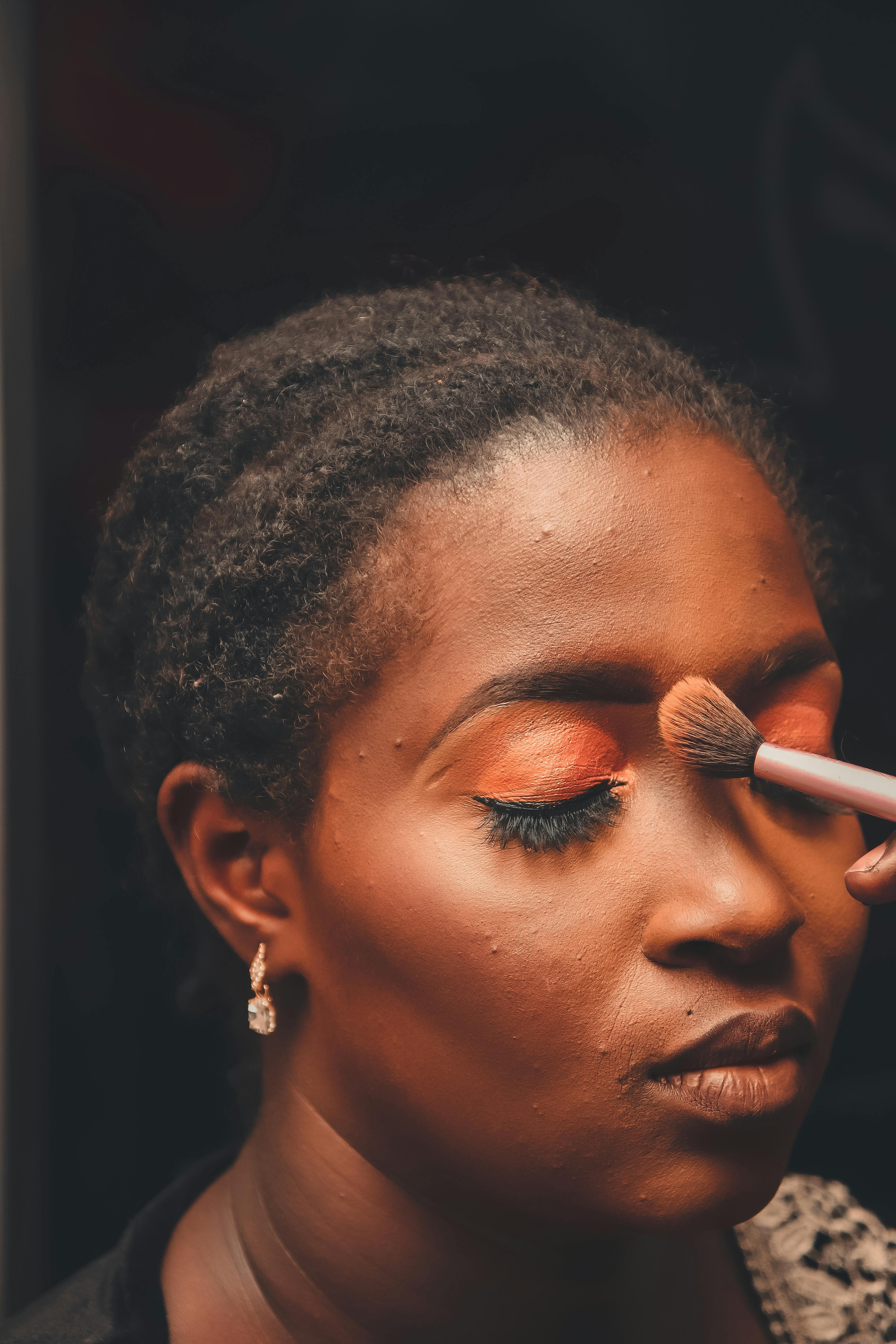 A Woman Using Makeup · Free Stock Photo