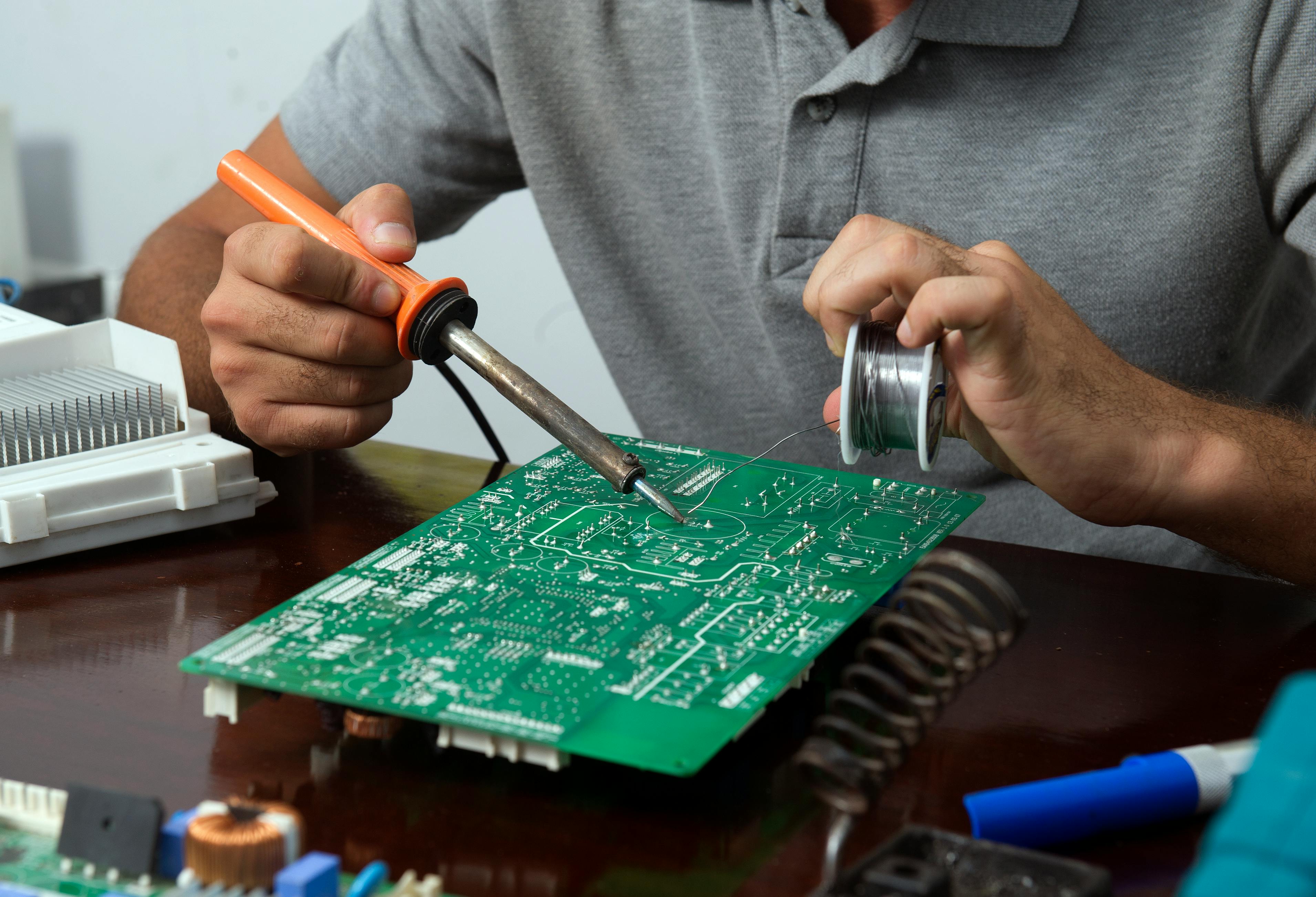 Man Working on a Circuit Board · Free Stock Photo
