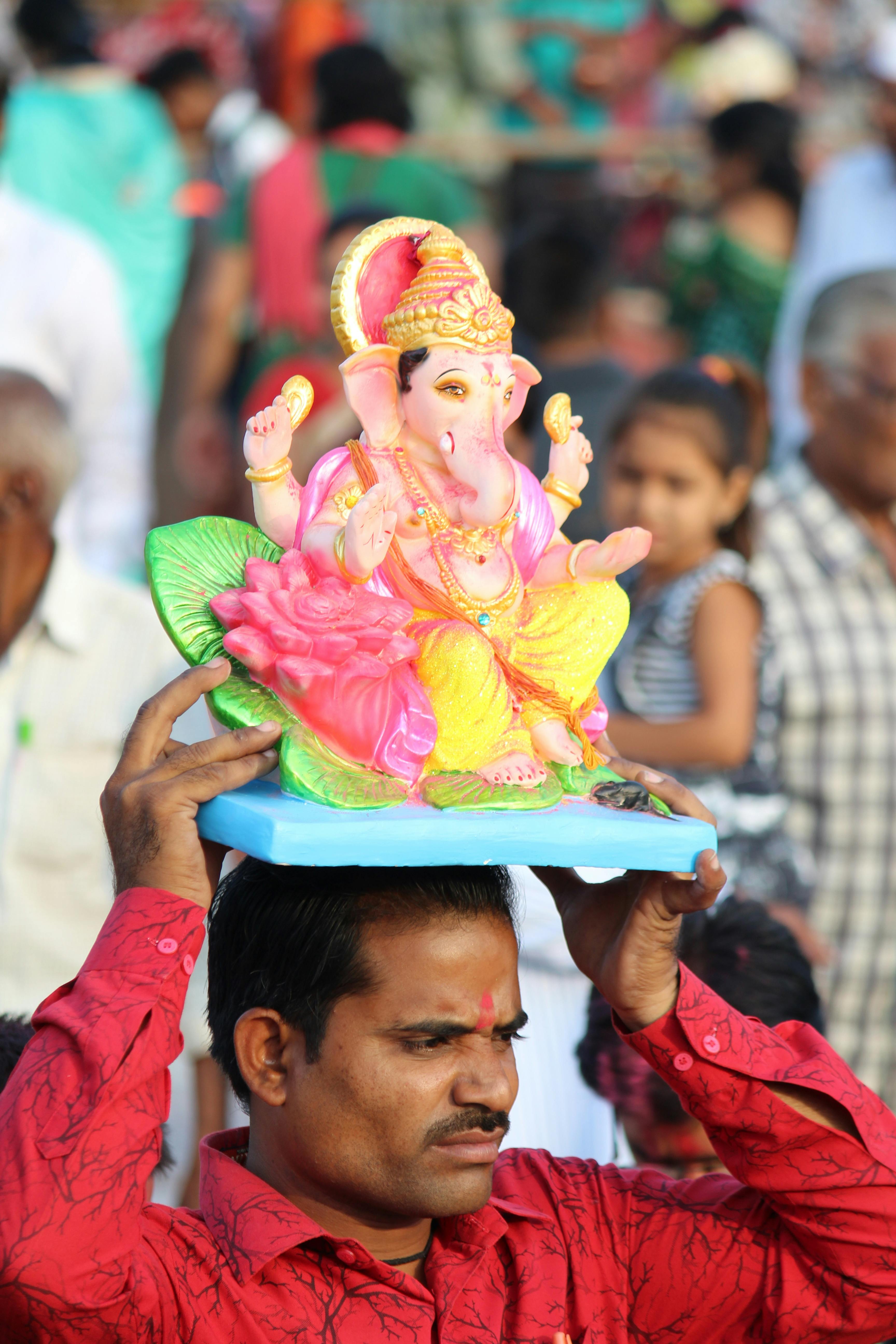 Man Holding Figure of Ganesha on Head · Free Stock Photo