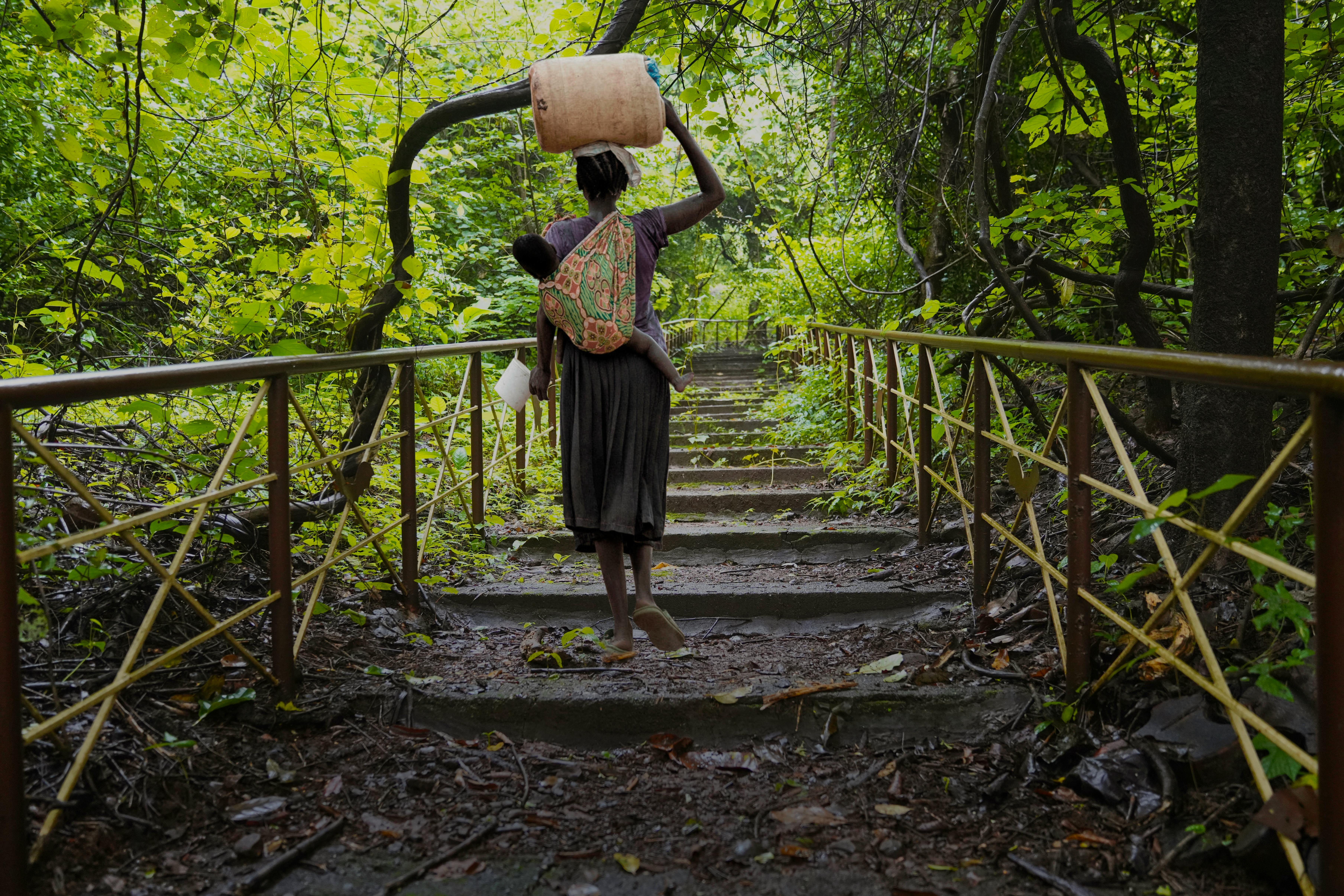 Woman Walking with Barrel on Head · Free Stock Photo