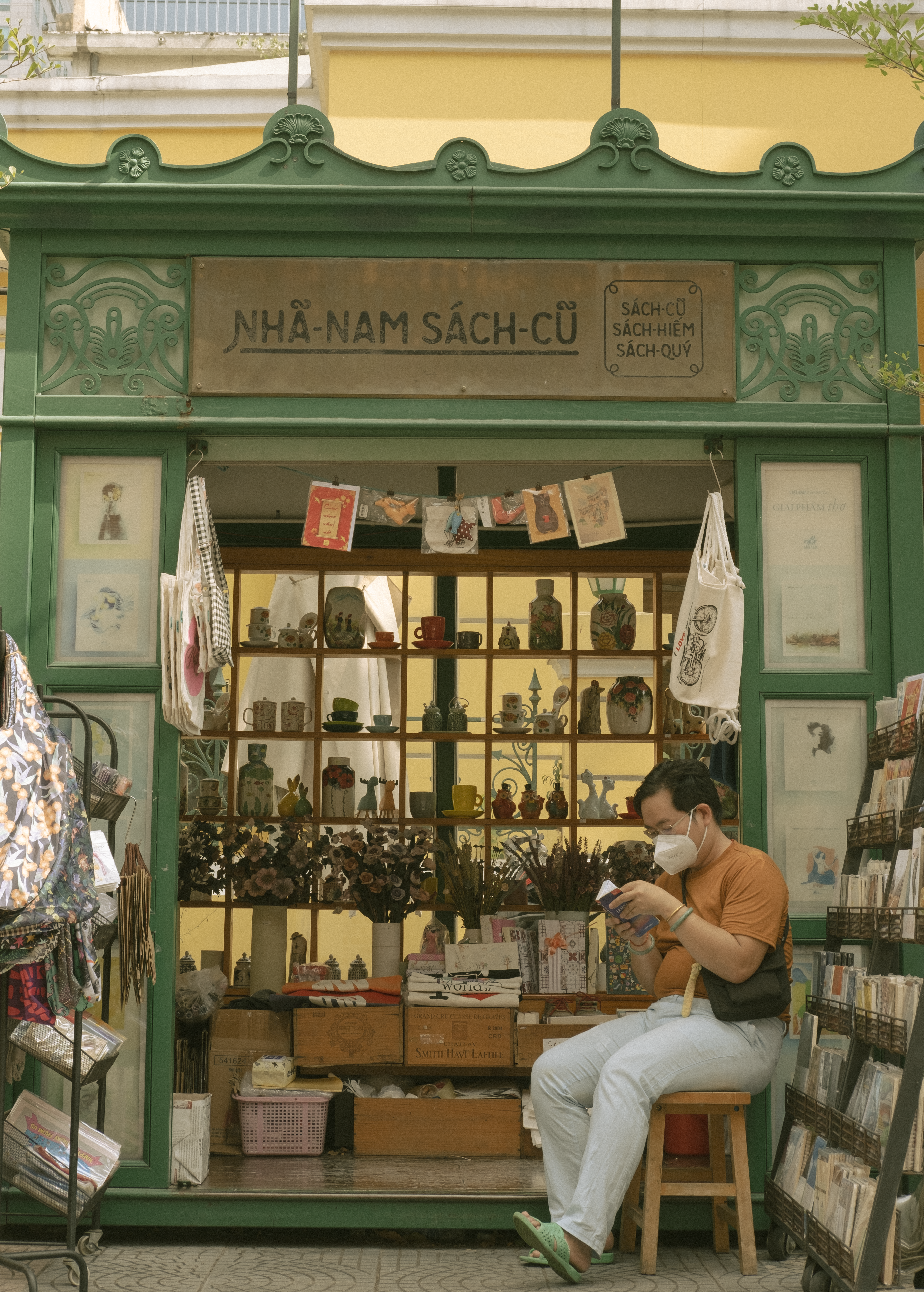 Man Sitting in front of Bookstore · Free Stock Photo