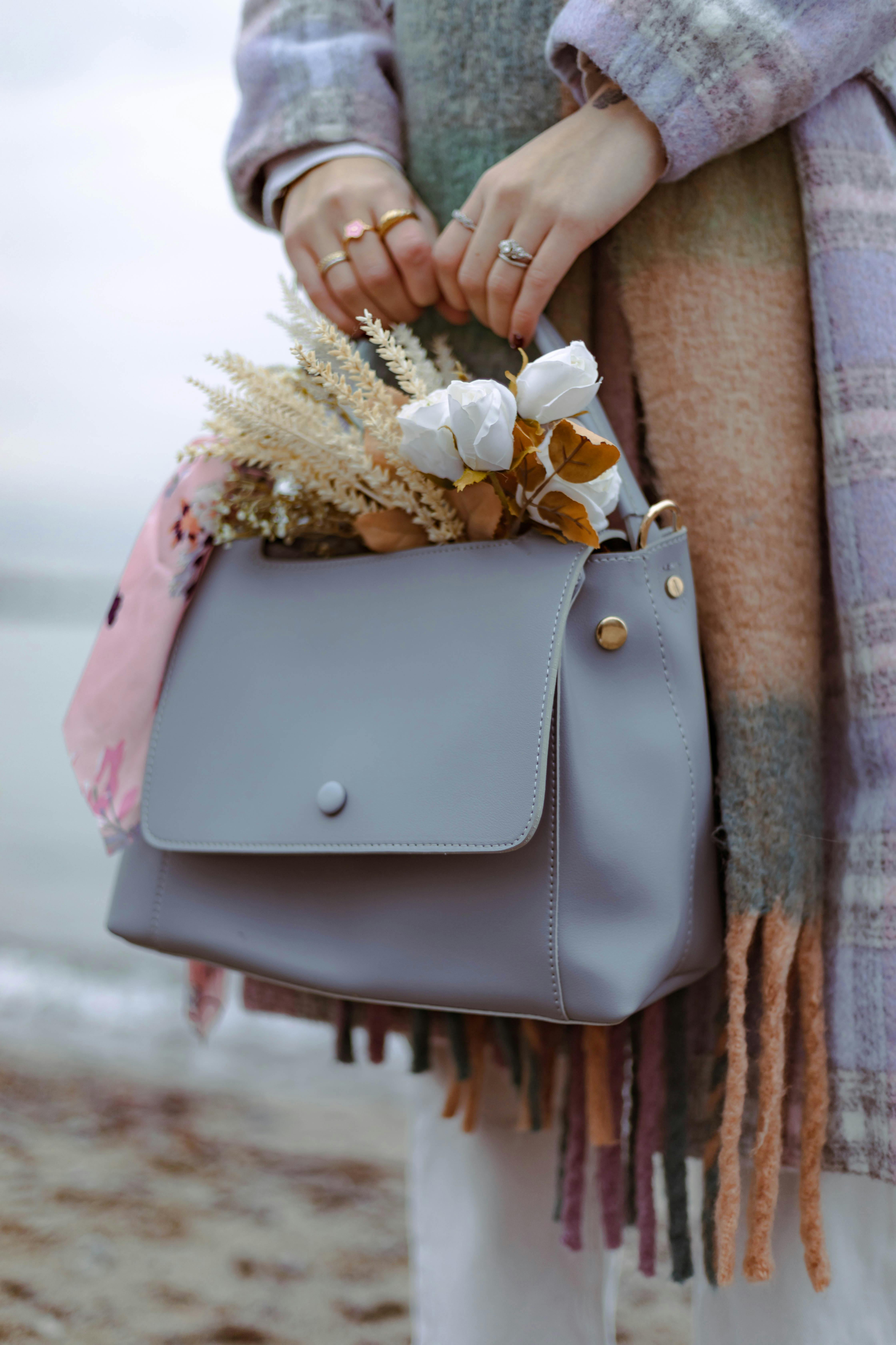 Woman Holding Handbag with Flowers Inside · Free Stock Photo