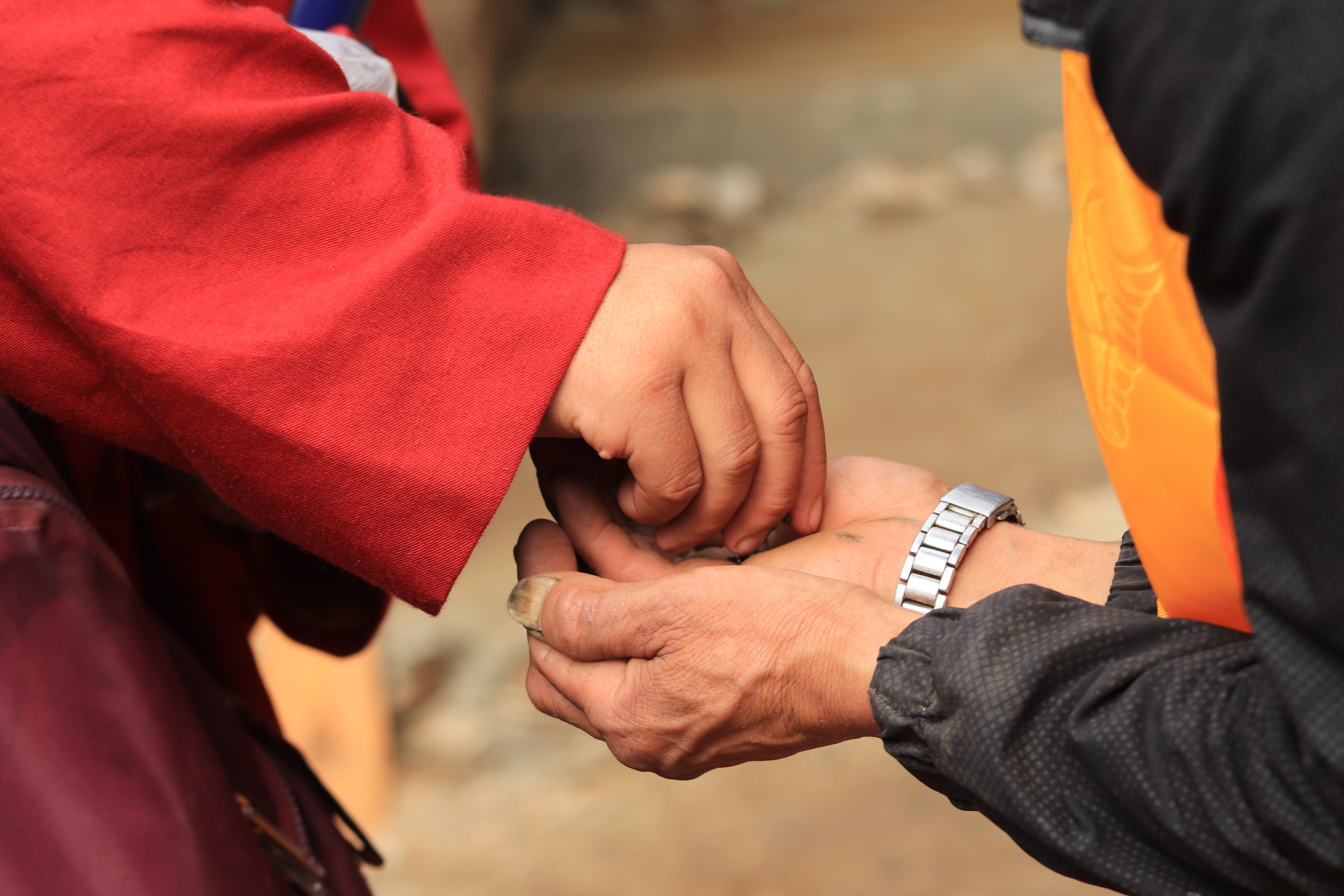 Hand Resting on a Person's Forearm · Free Stock Photo