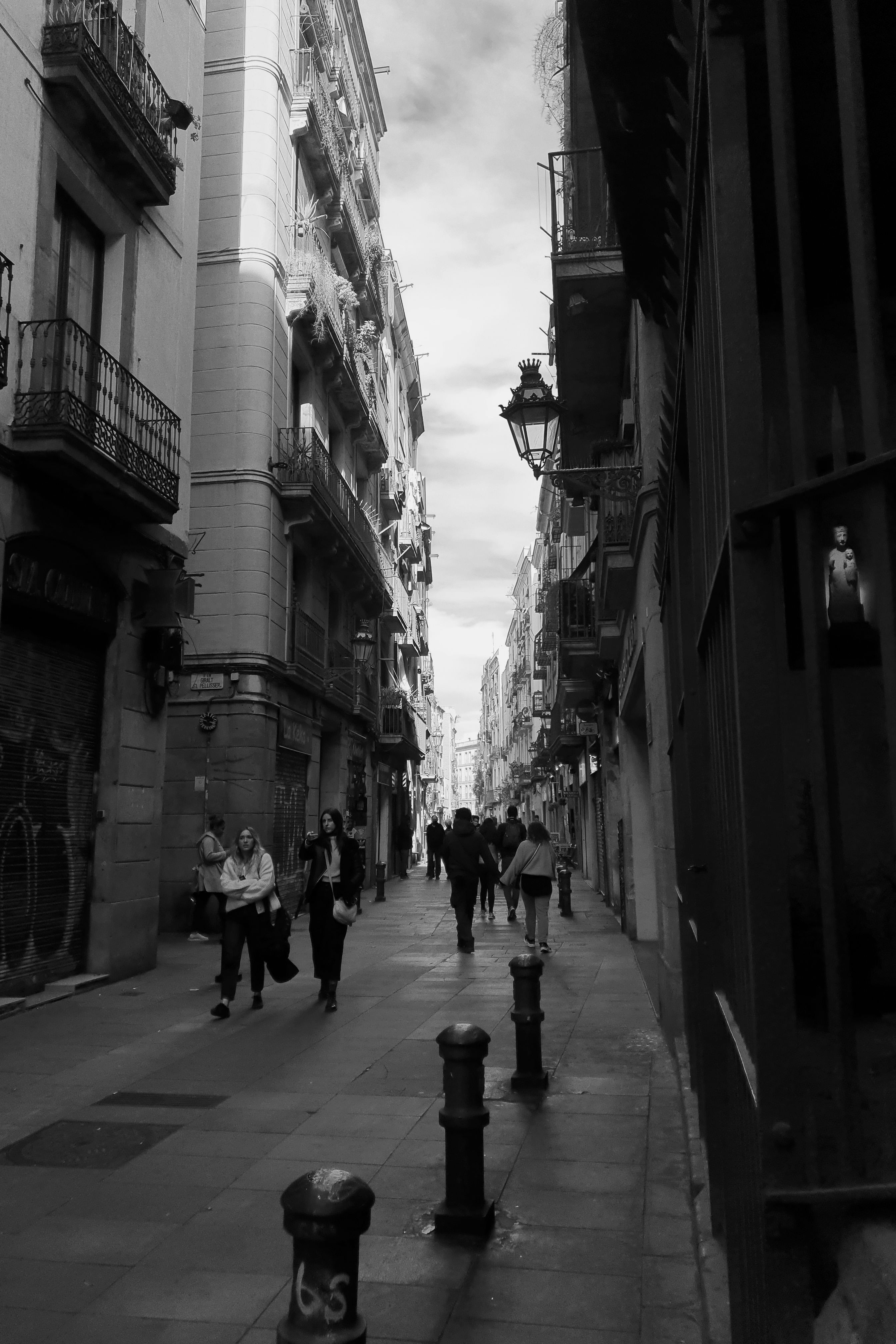People Walking on the Street Between Buildings · Free Stock Photo