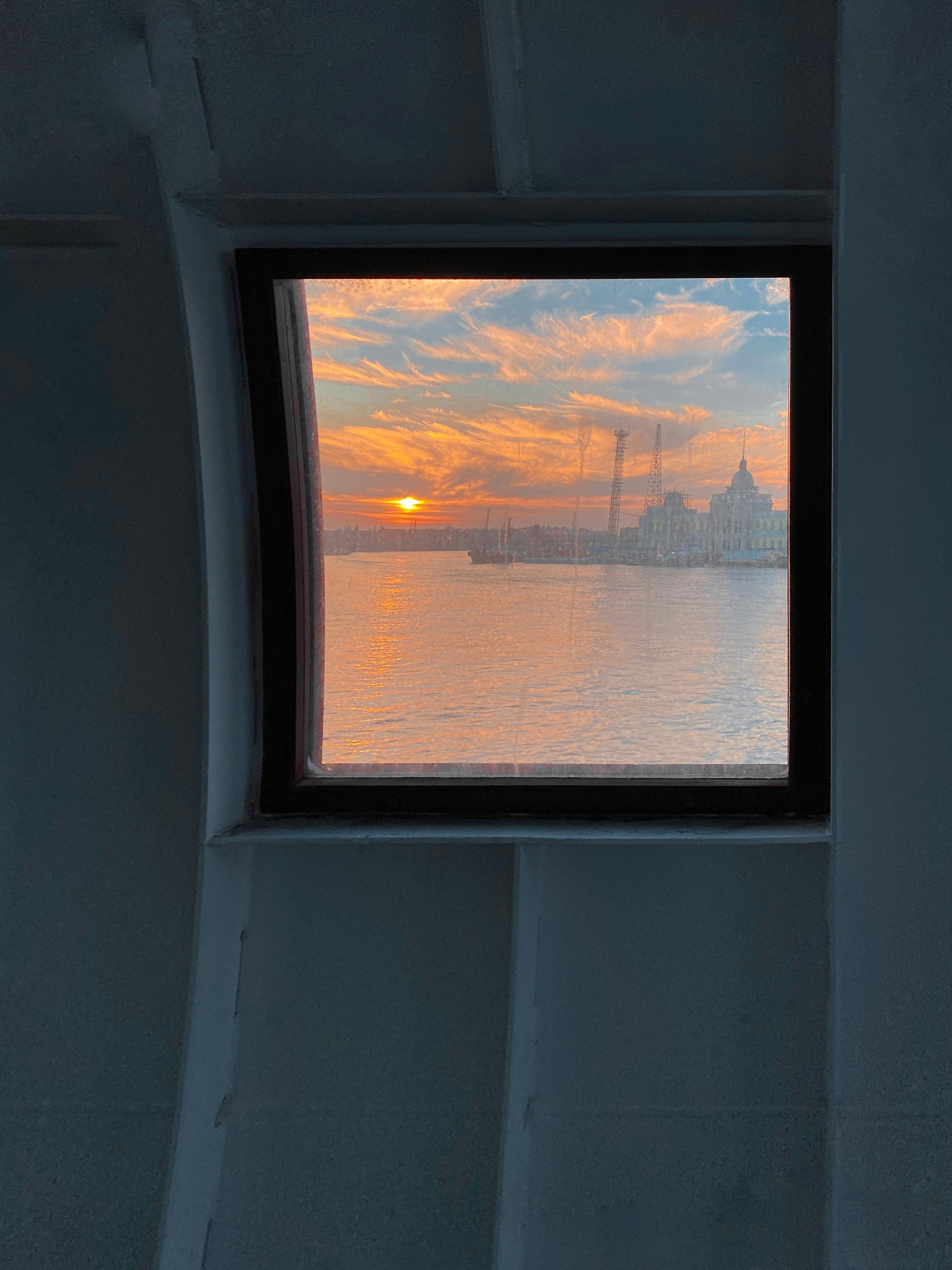 Waterfront at Sunset Seen from a Ferry Window · Free Stock Photo