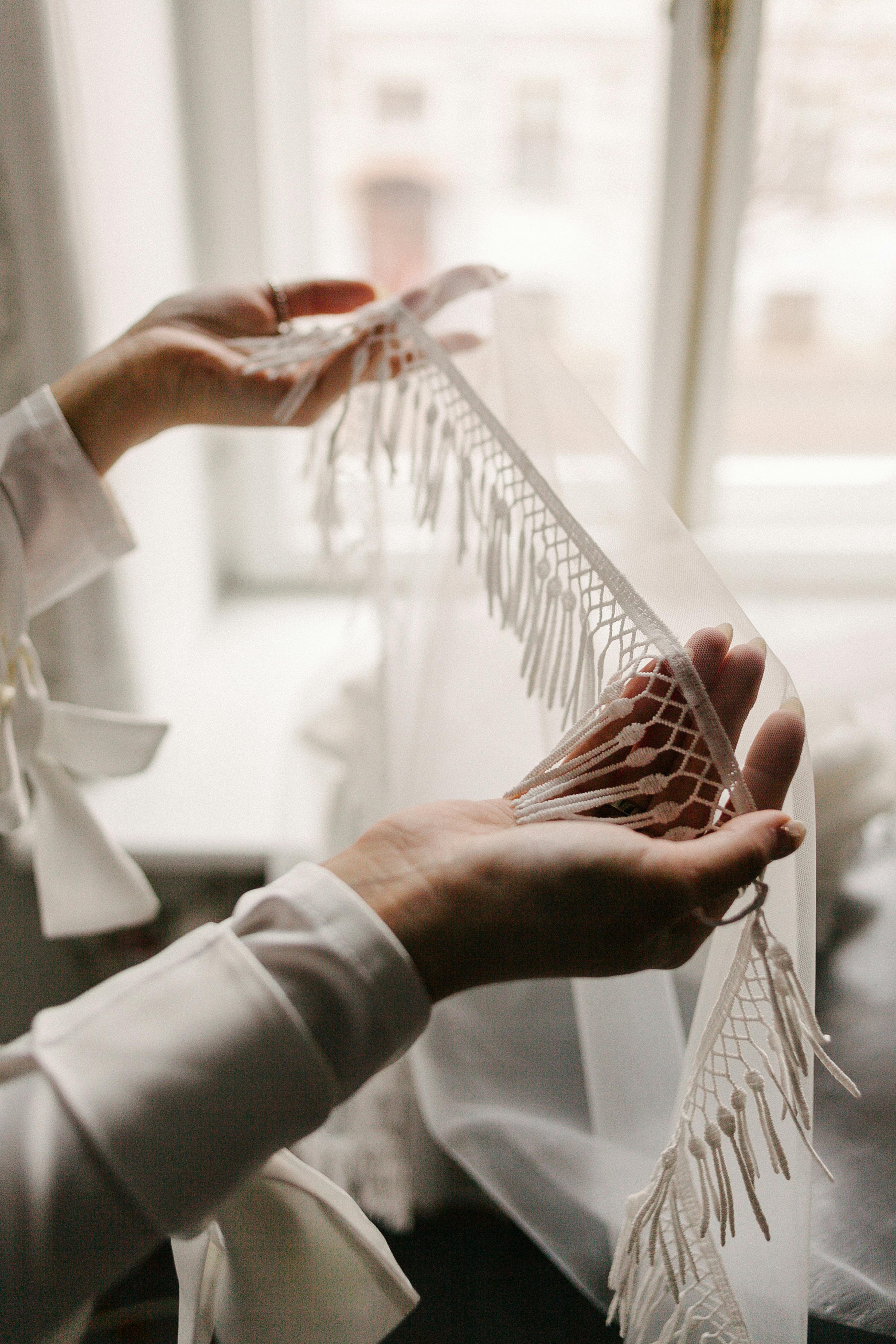 Hands Holding Fabric with Fringe · Free Stock Photo