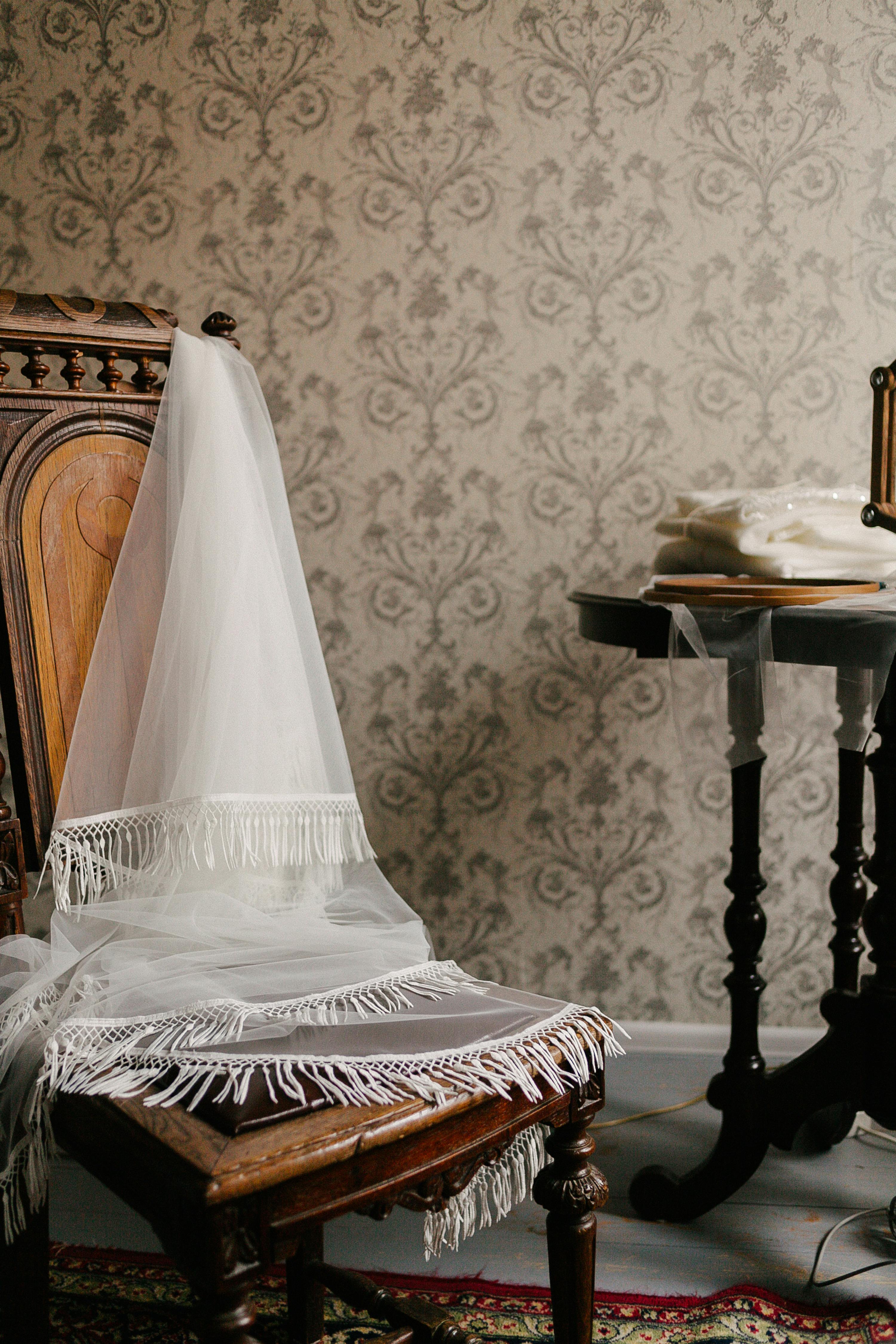 White Fabric with Fringe Draped over Chair · Free Stock Photo