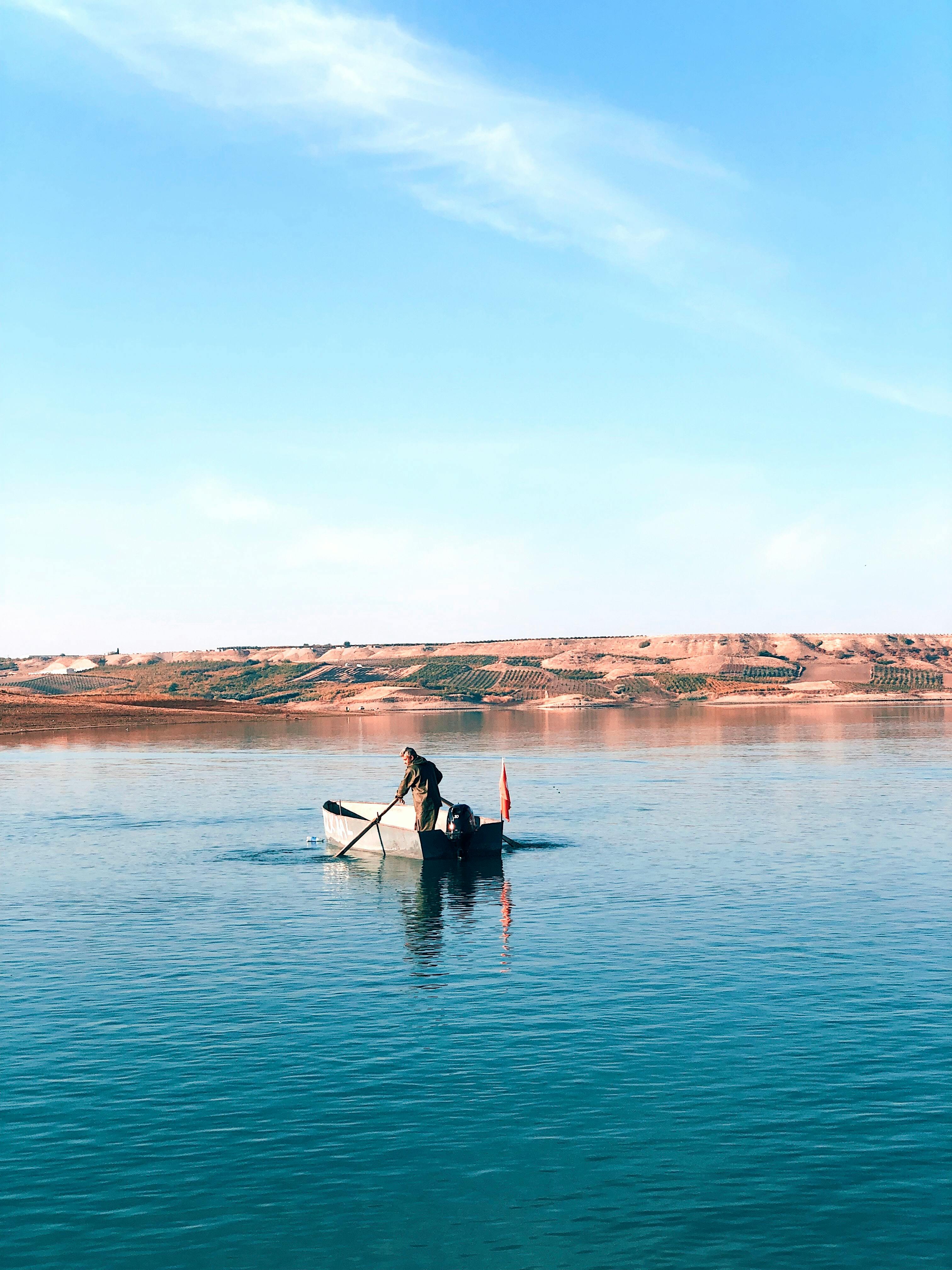 Person Riding a Boat · Free Stock Photo