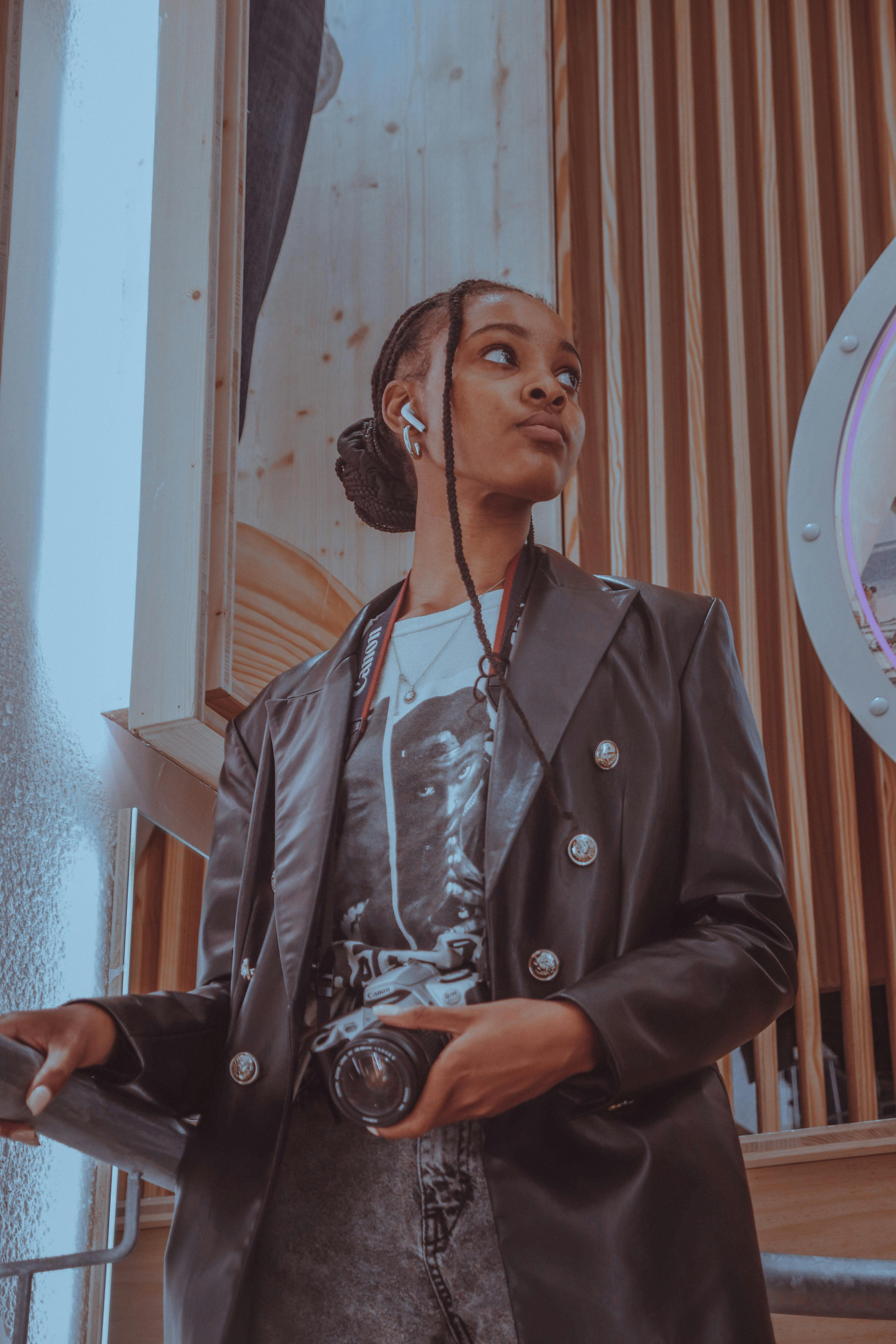 Woman Pinning Photos on Corkboard · Free Stock Photo