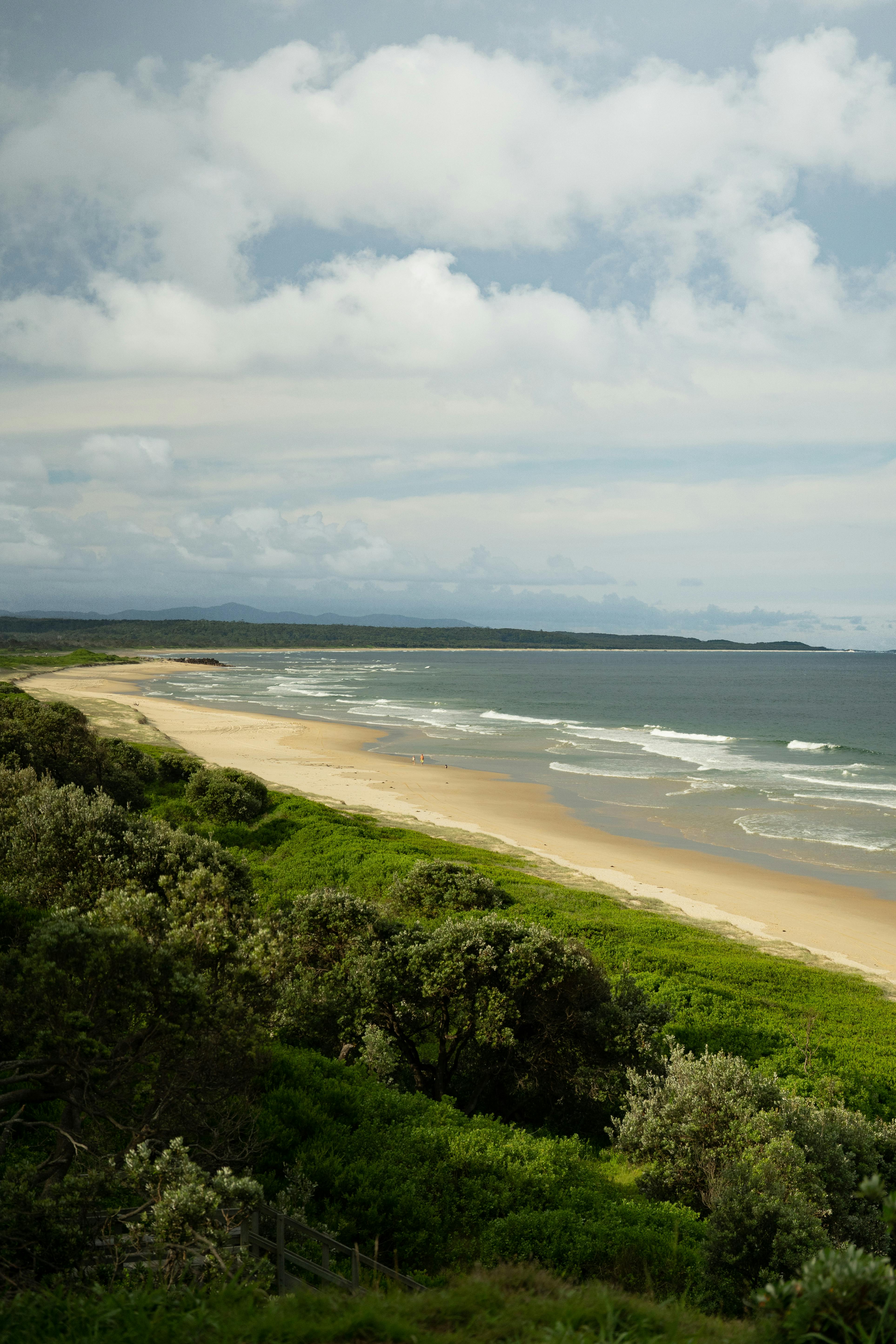Green Grass Field Near Sea Under White Clouds · Free Stock Photo