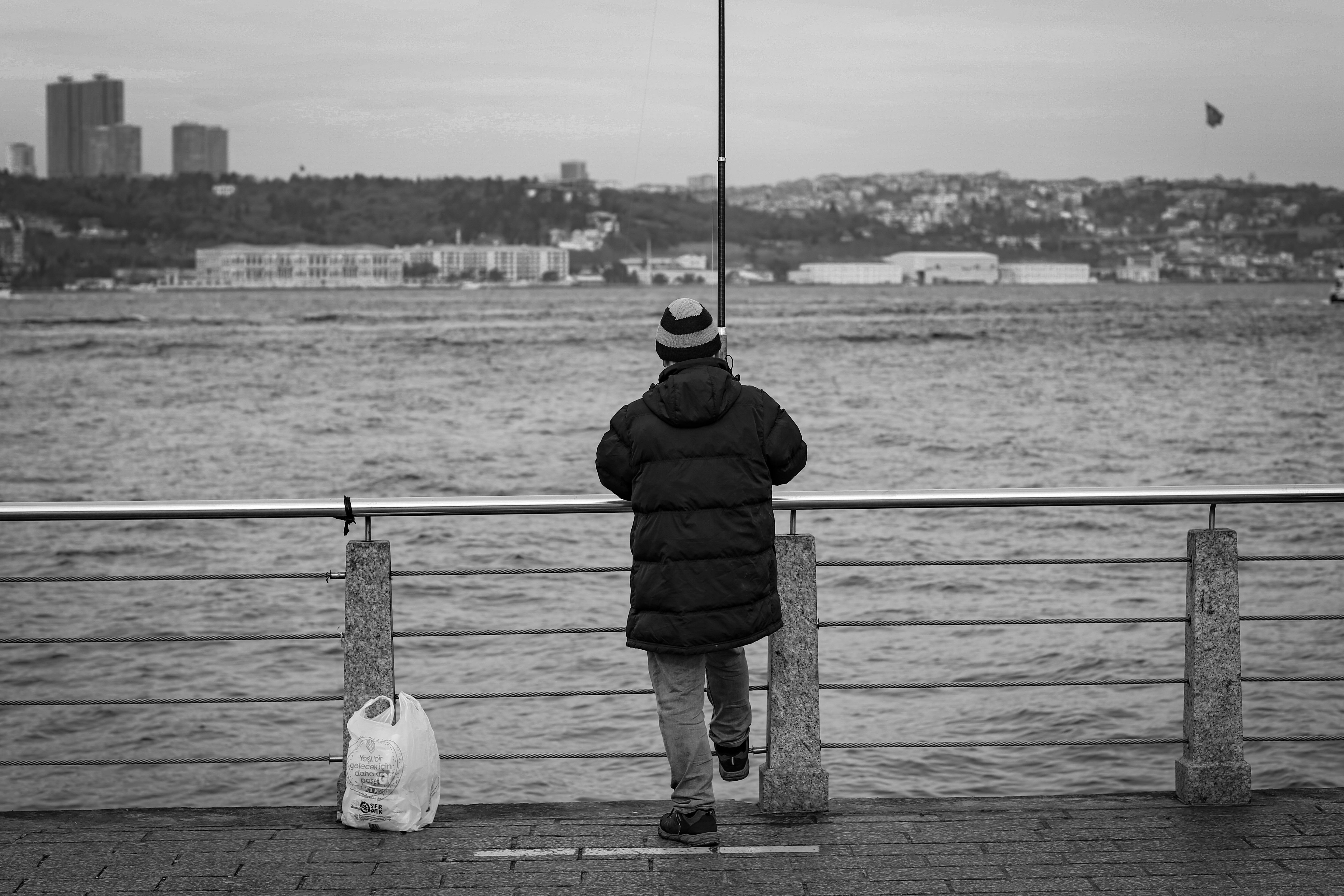 Grayscale Photo of Men Fishing · Free Stock Photo