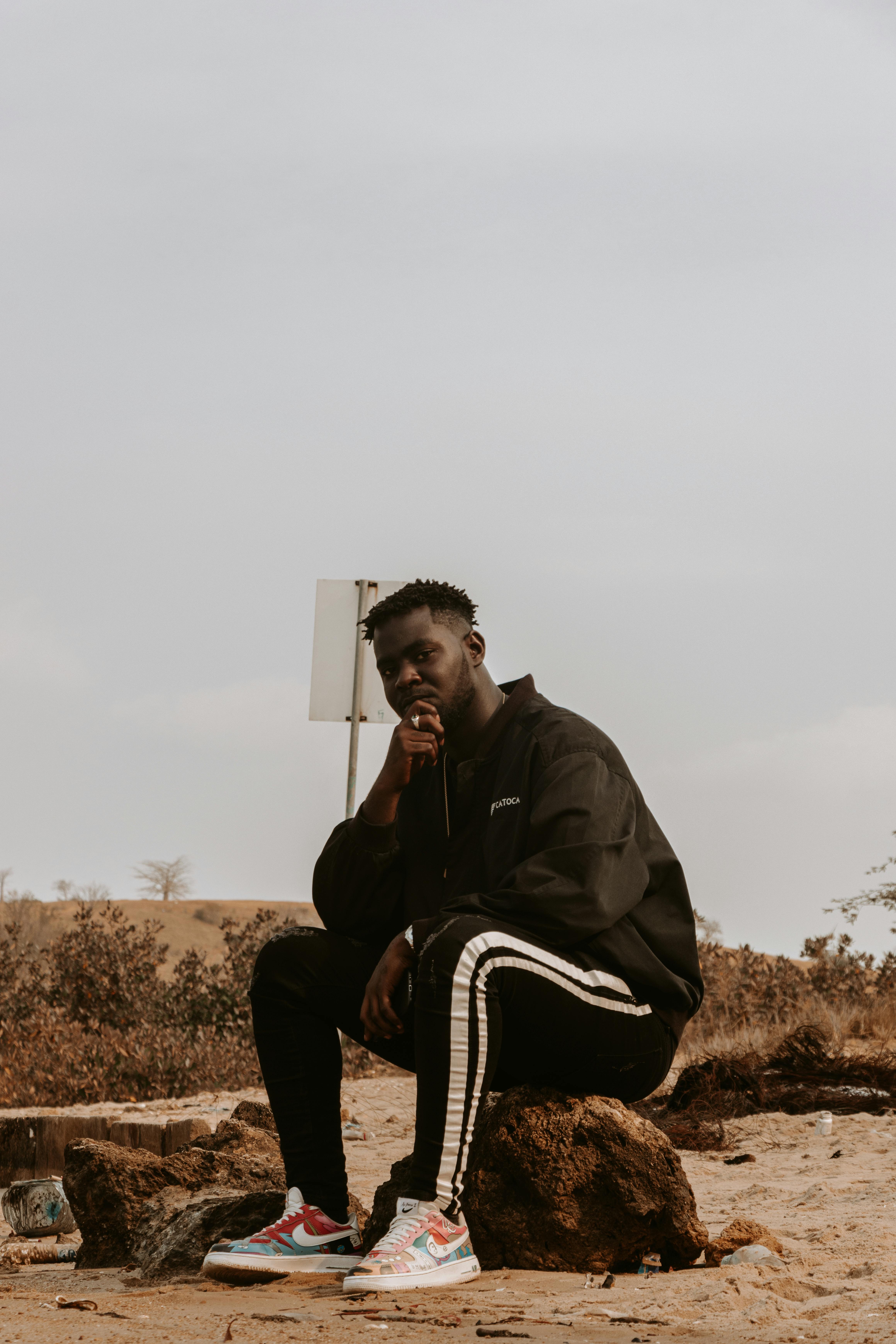 A Man in Black Jacket with His Hand on His Chin · Free Stock Photo