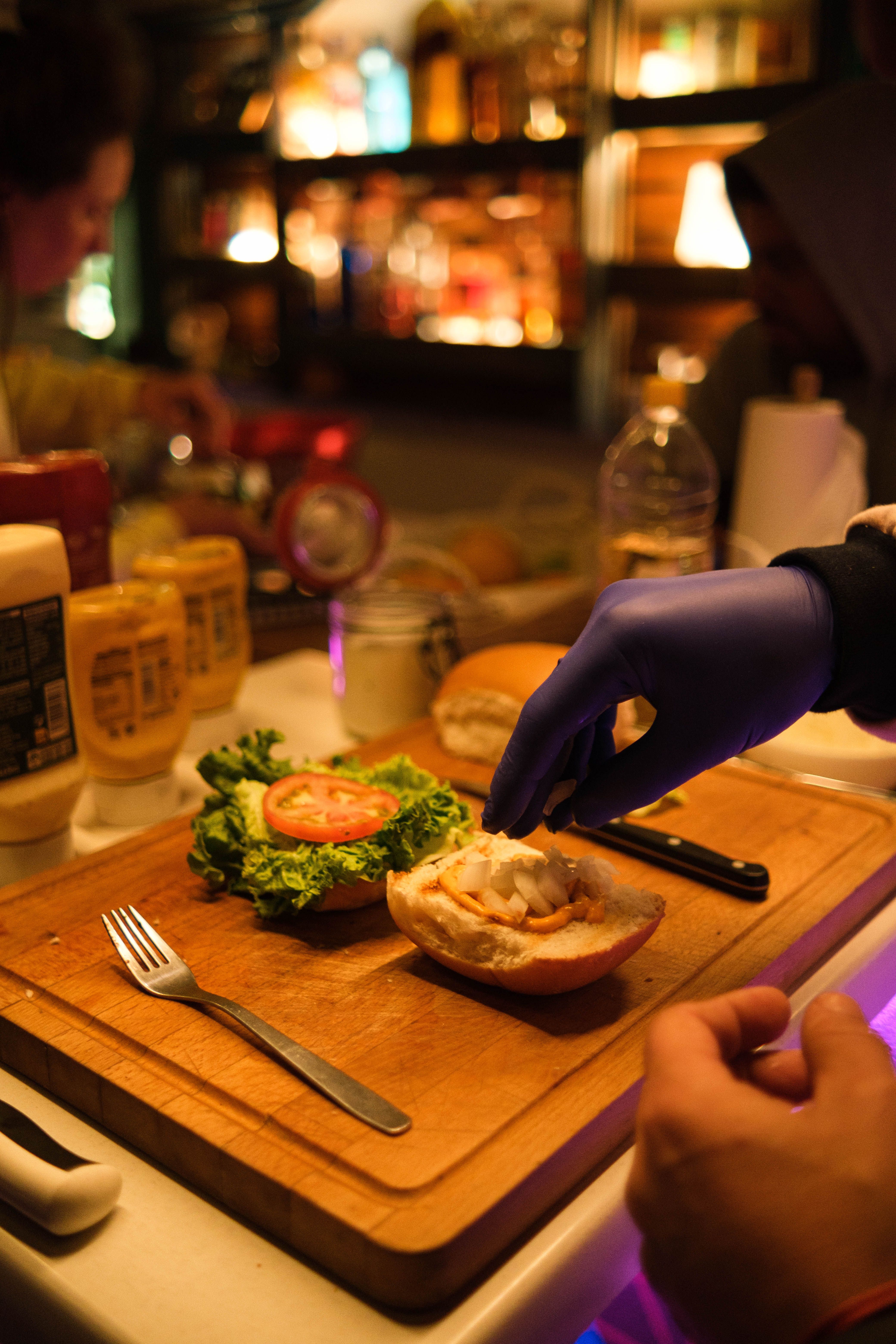 A Person Preparing a Burger · Free Stock Photo