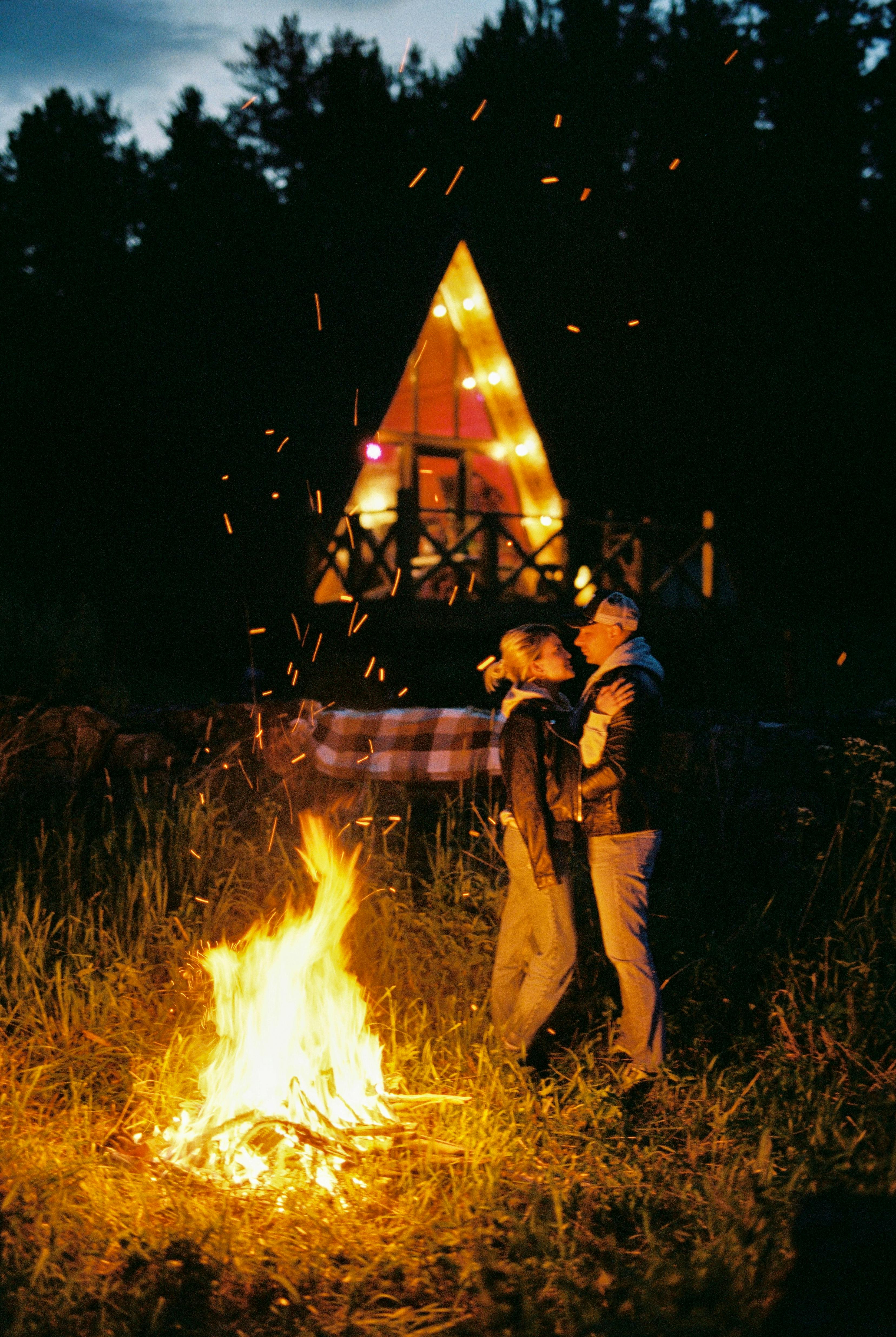Couple standing near a Bonfire · Free Stock Photo