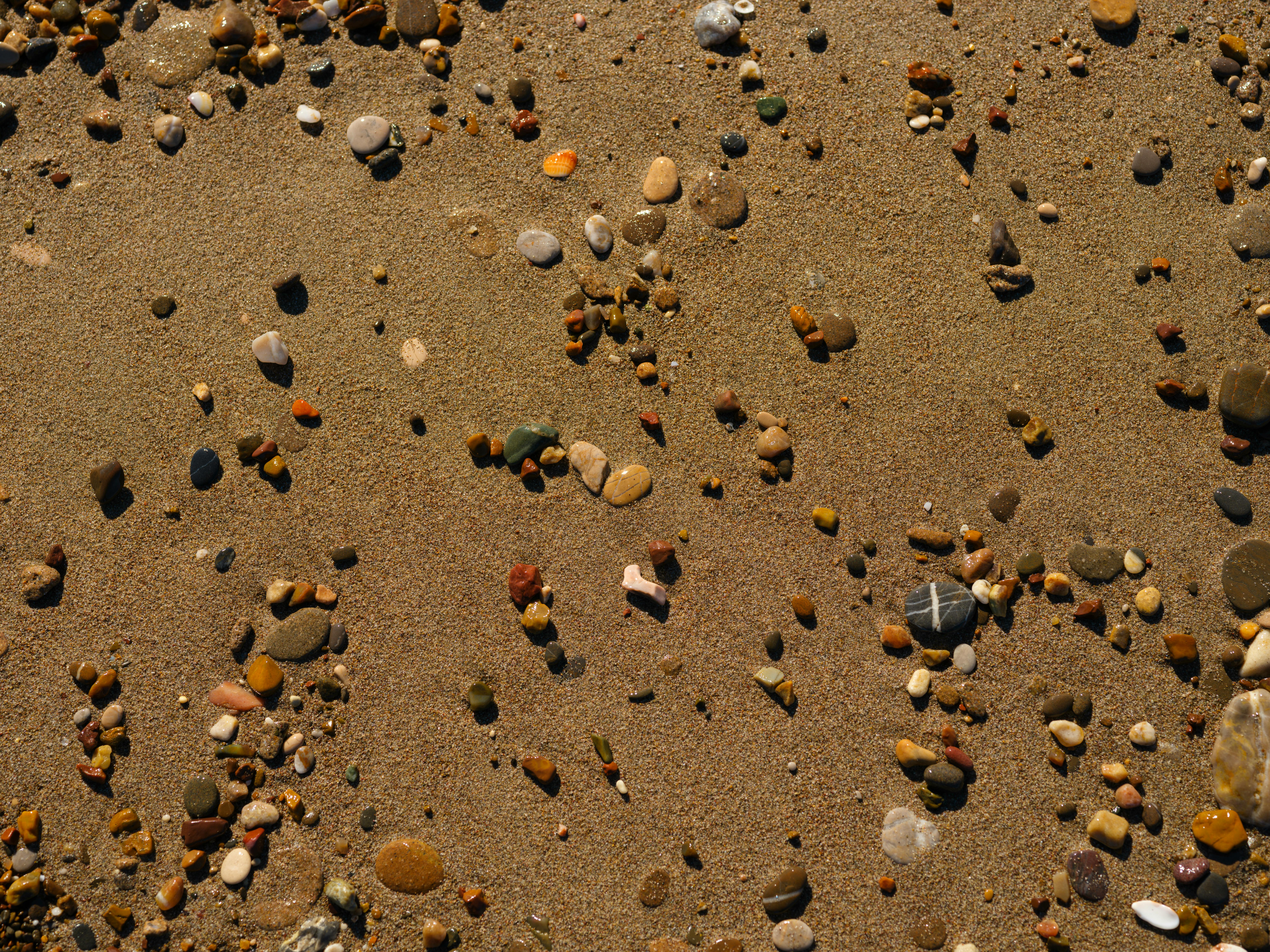 Peebles and Stones on Brown Sand · Free Stock Photo