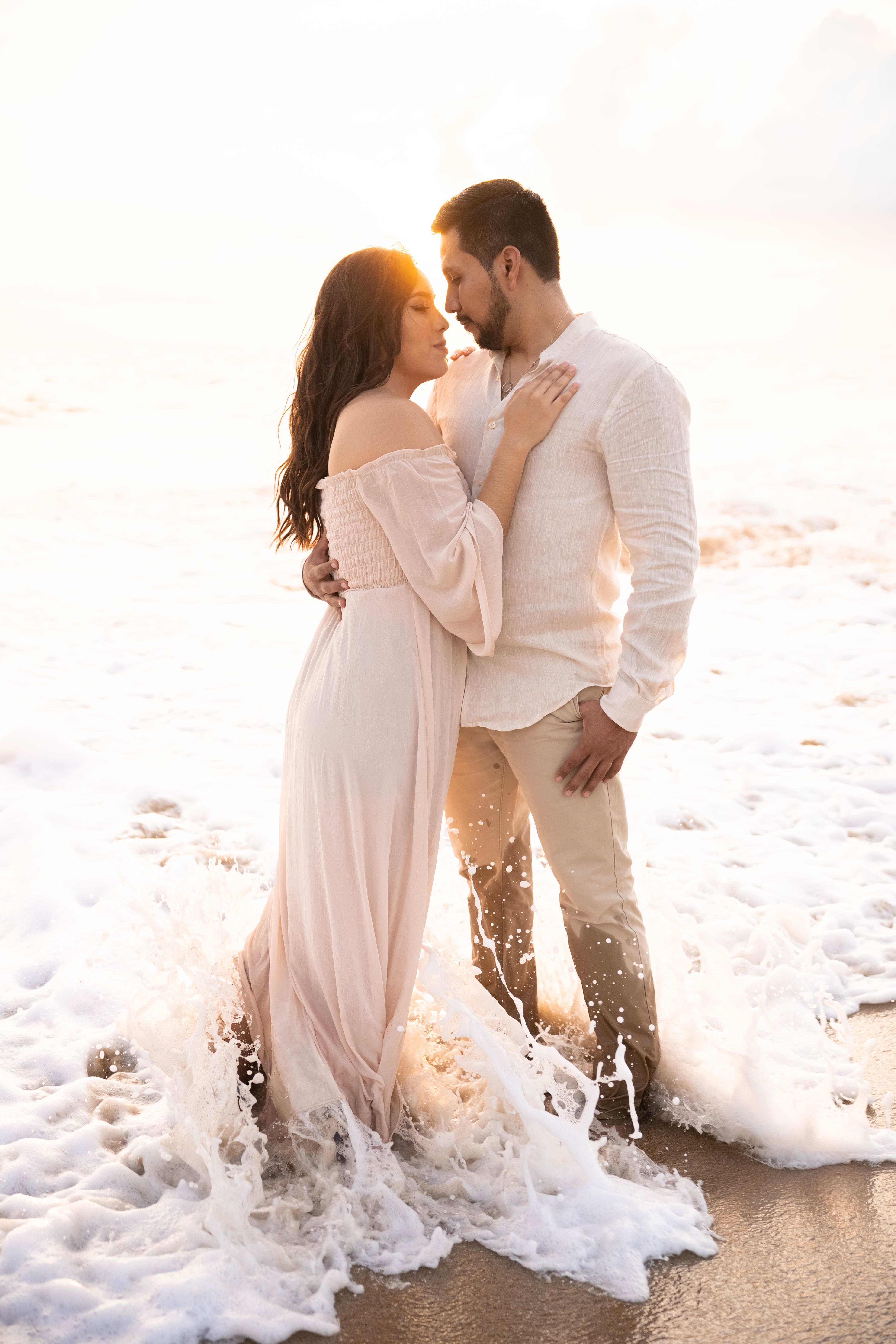 A Couple Kissing Near a Body of Water · Free Stock Photo