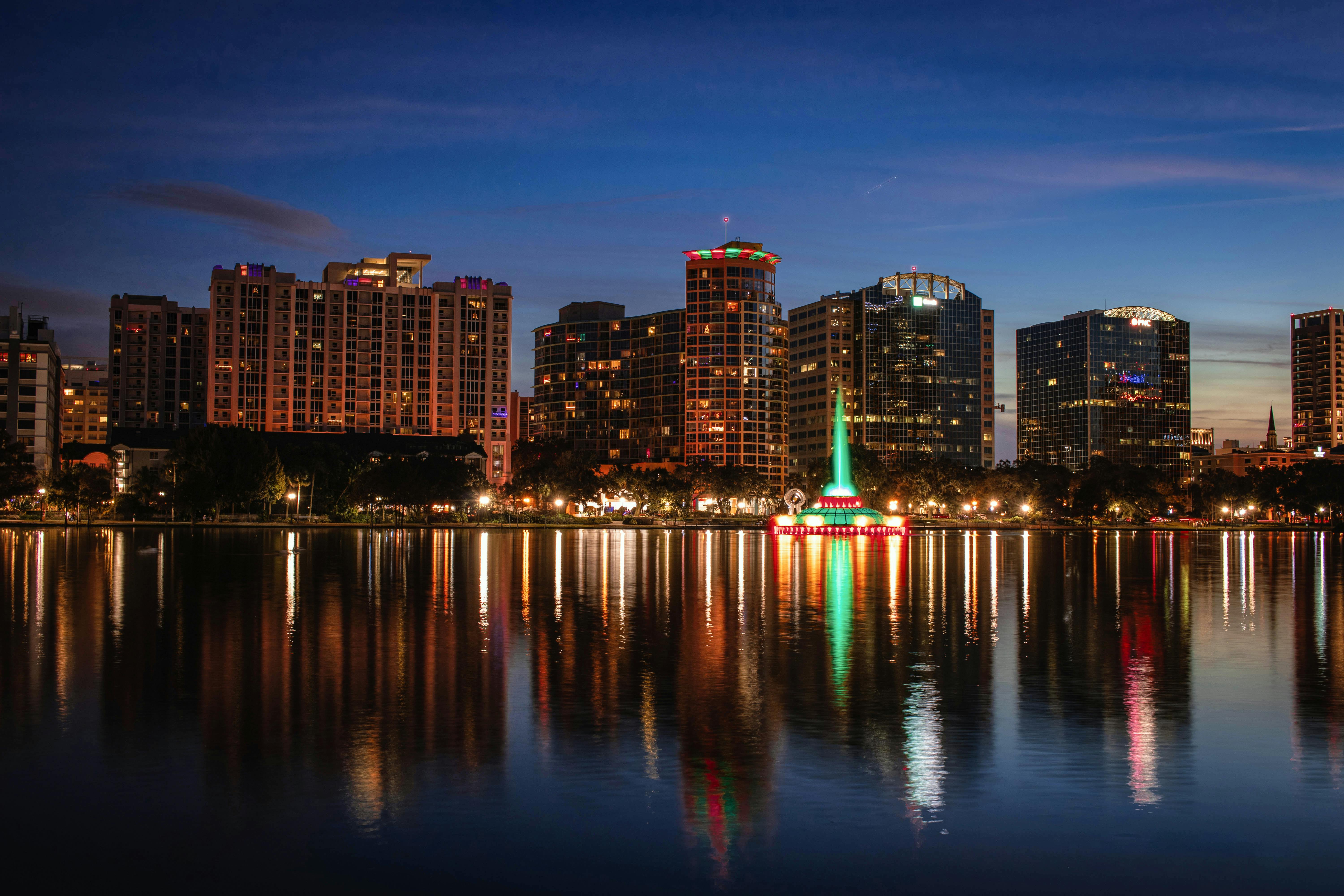 Lighted Buildings during Nighttime Near Body of Water · Free Stock Photo