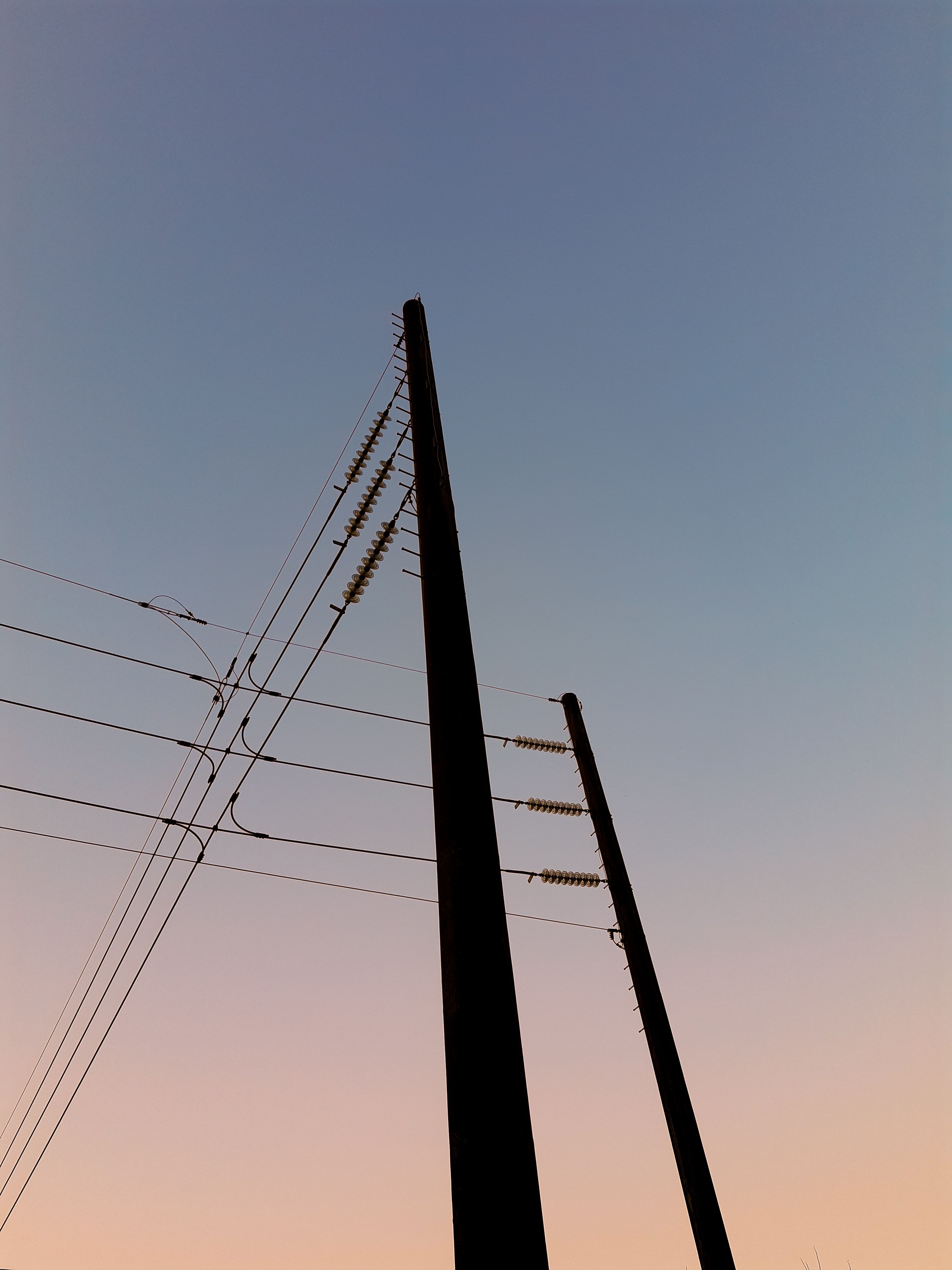 Black Electric Poles Under Blue Sky · Free Stock Photo