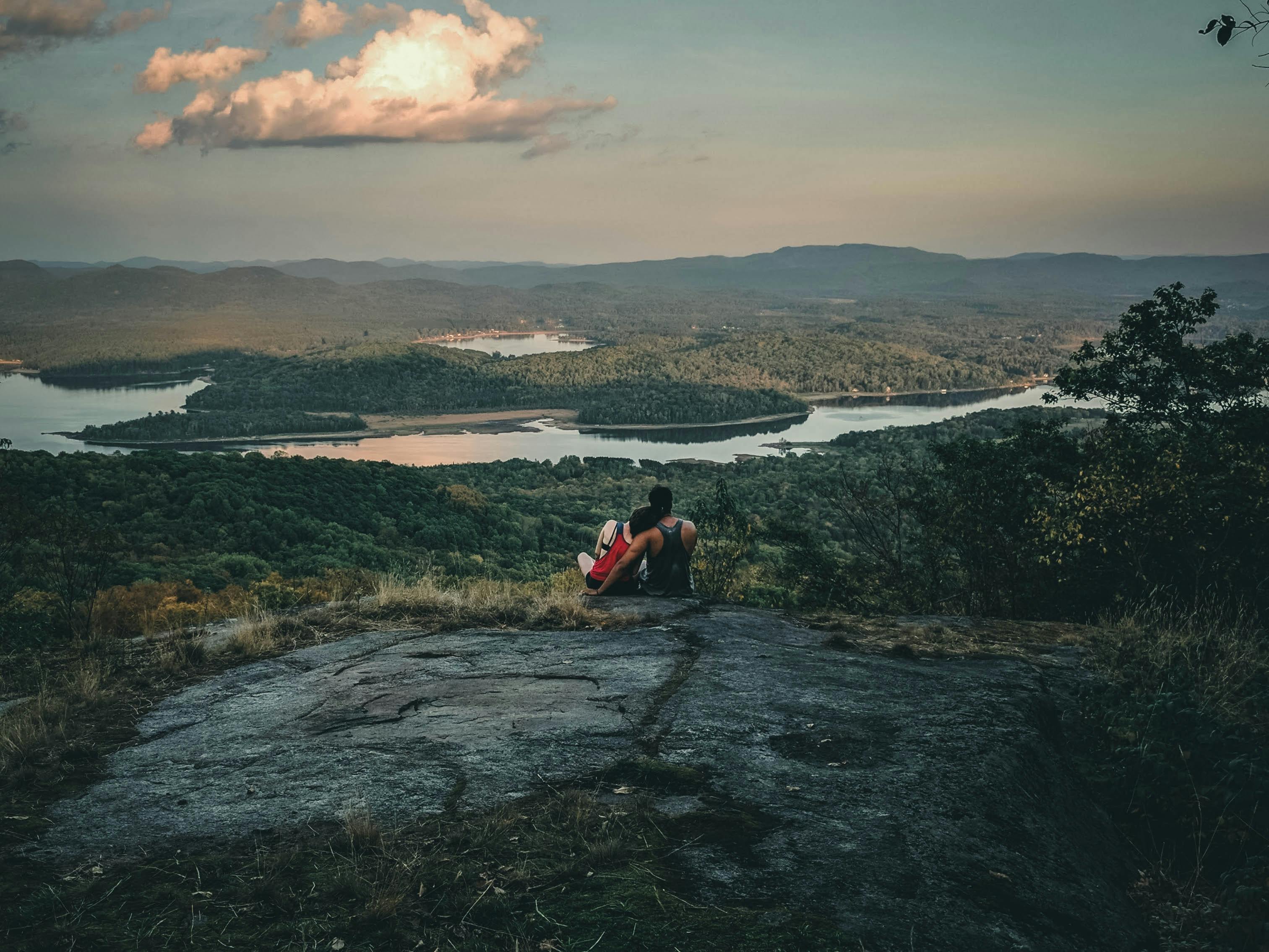 A Man and a Woman Sitting on Rock Formation · Free Stock Photo