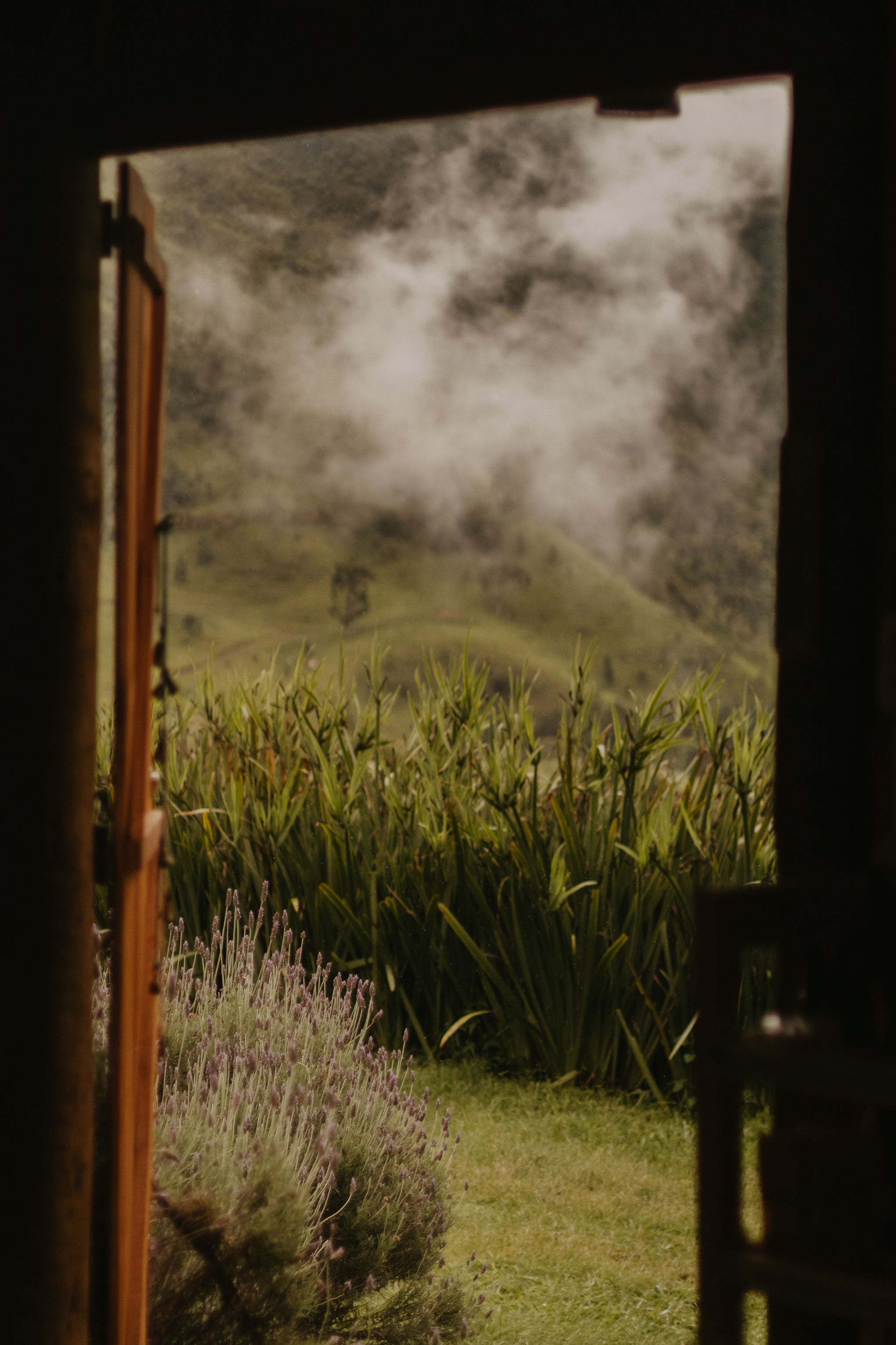Foggy Mountain View Through an Opened Wooden Door · Free Stock Photo