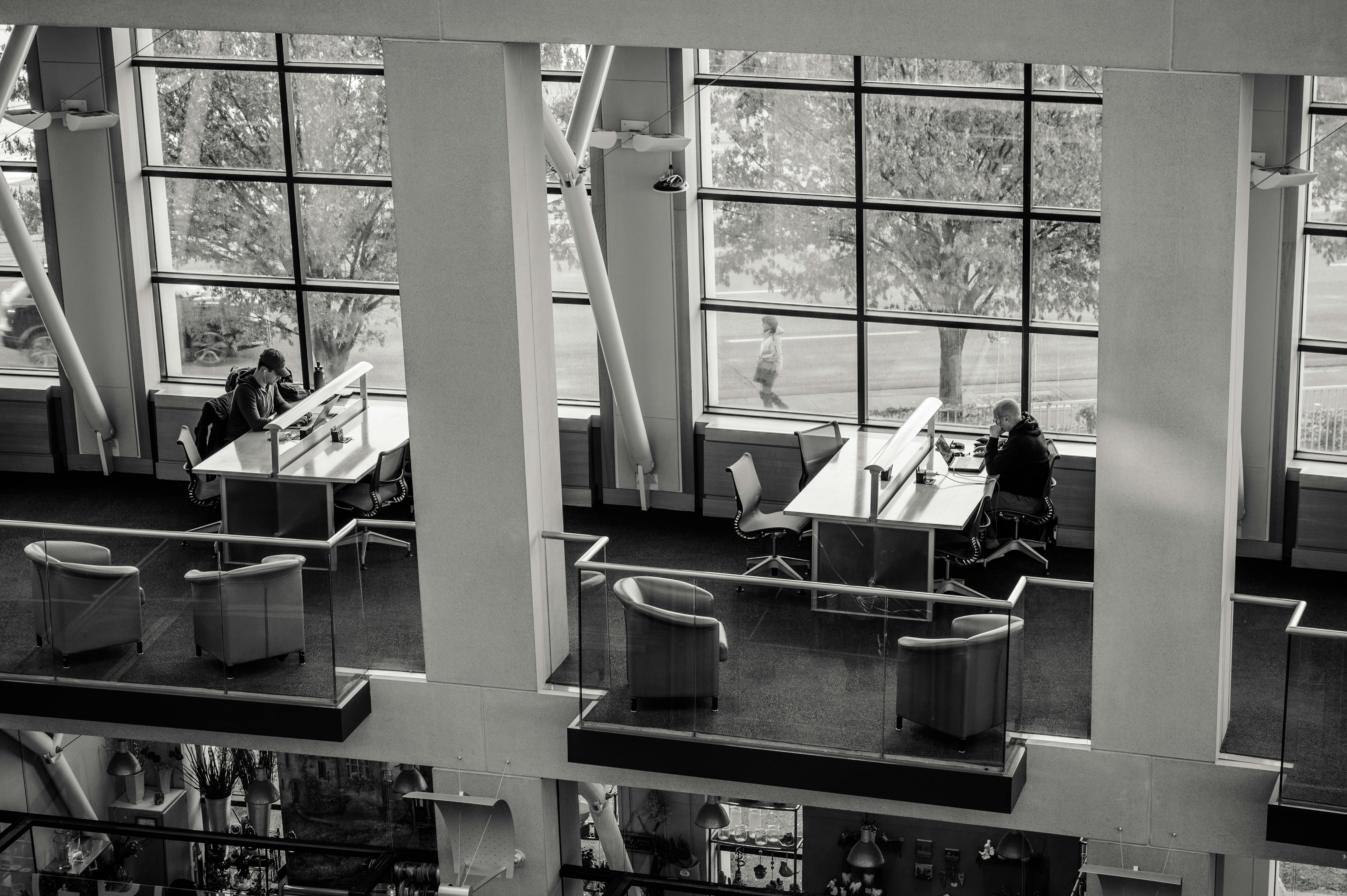 People Sitting in Modern Two Storey Library · Free Stock Photo