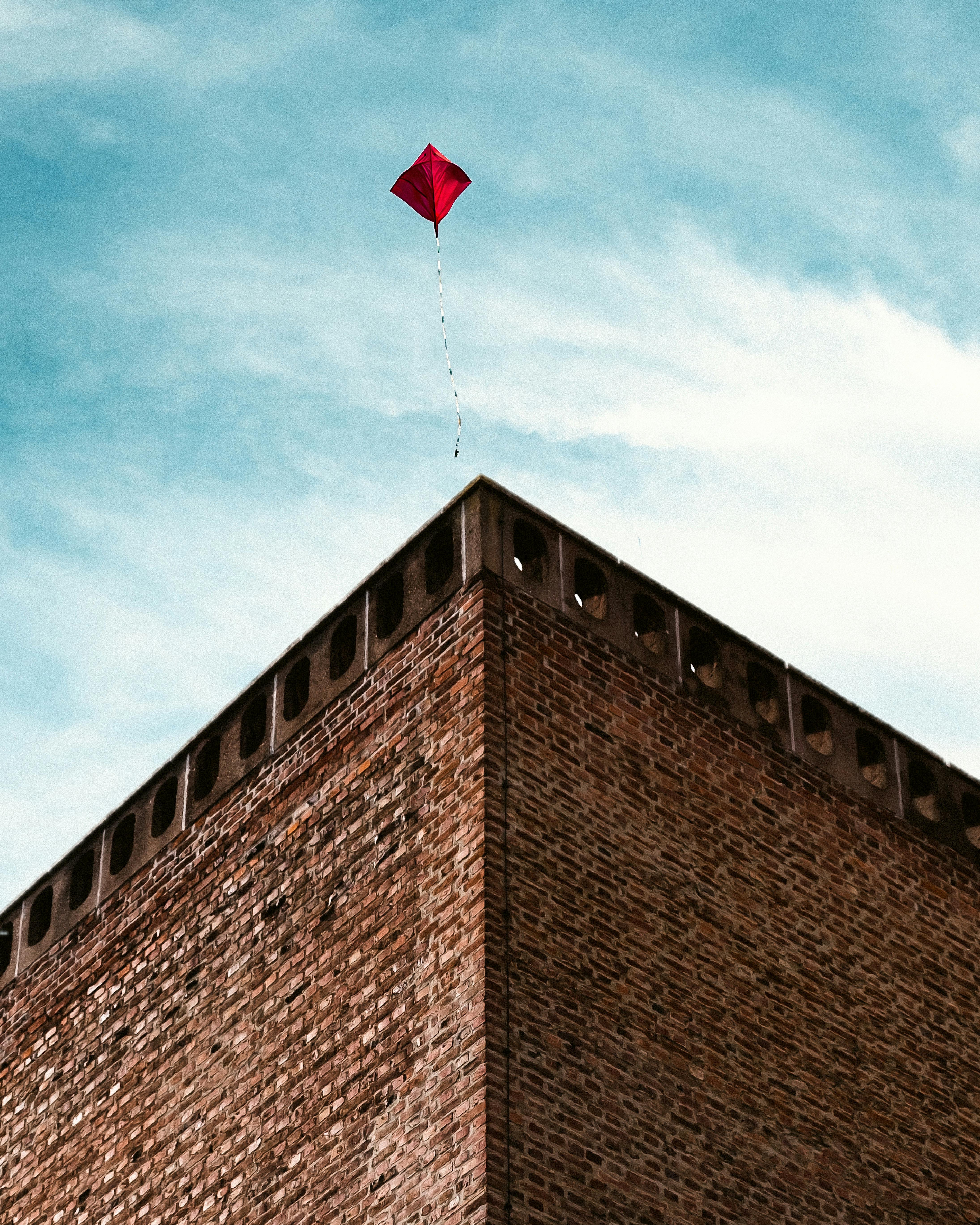 Kite Flying over a Building · Free Stock Photo