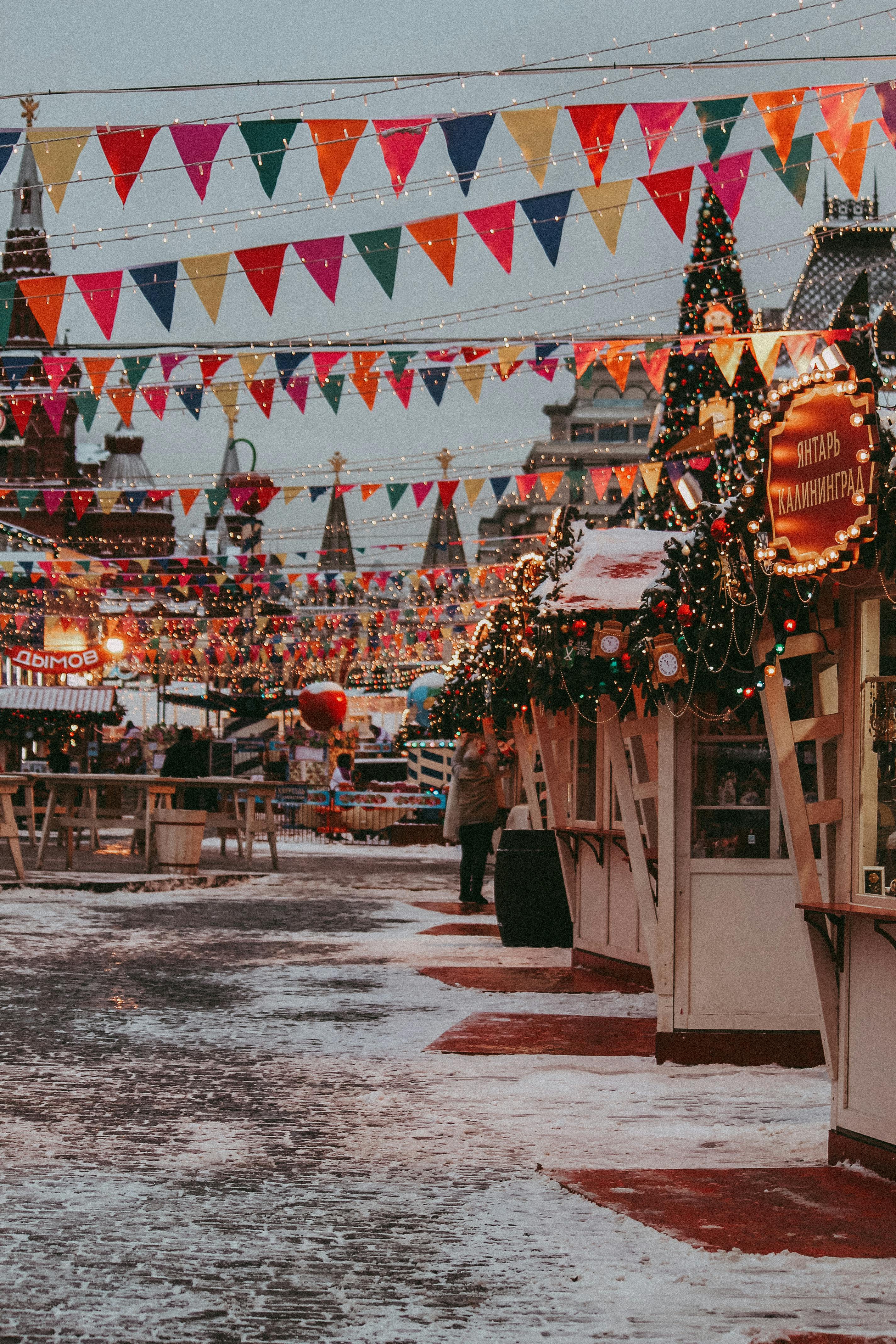 Flag Banners Hanging Over Snow Covered Road · Free Stock Photo