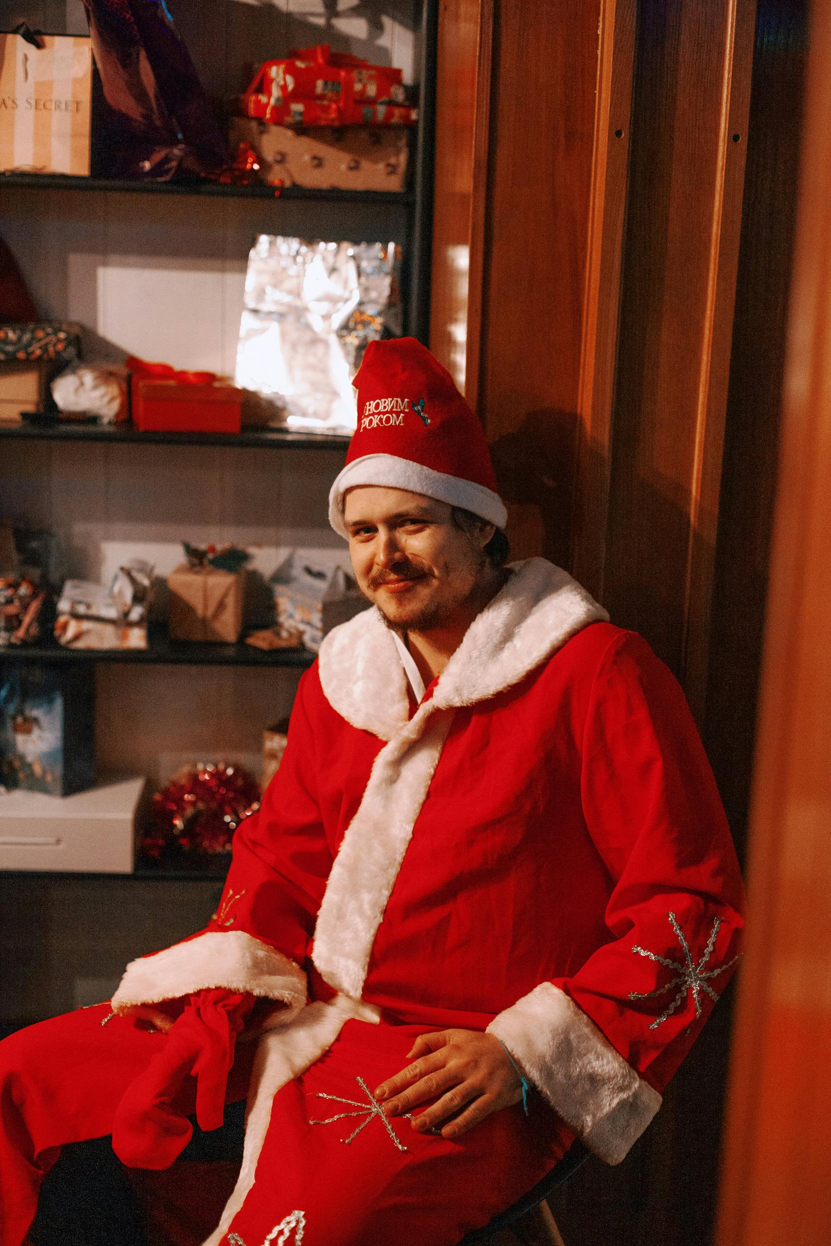 Man In Santa Outfit Flexing His Muscles · Free Stock Photo