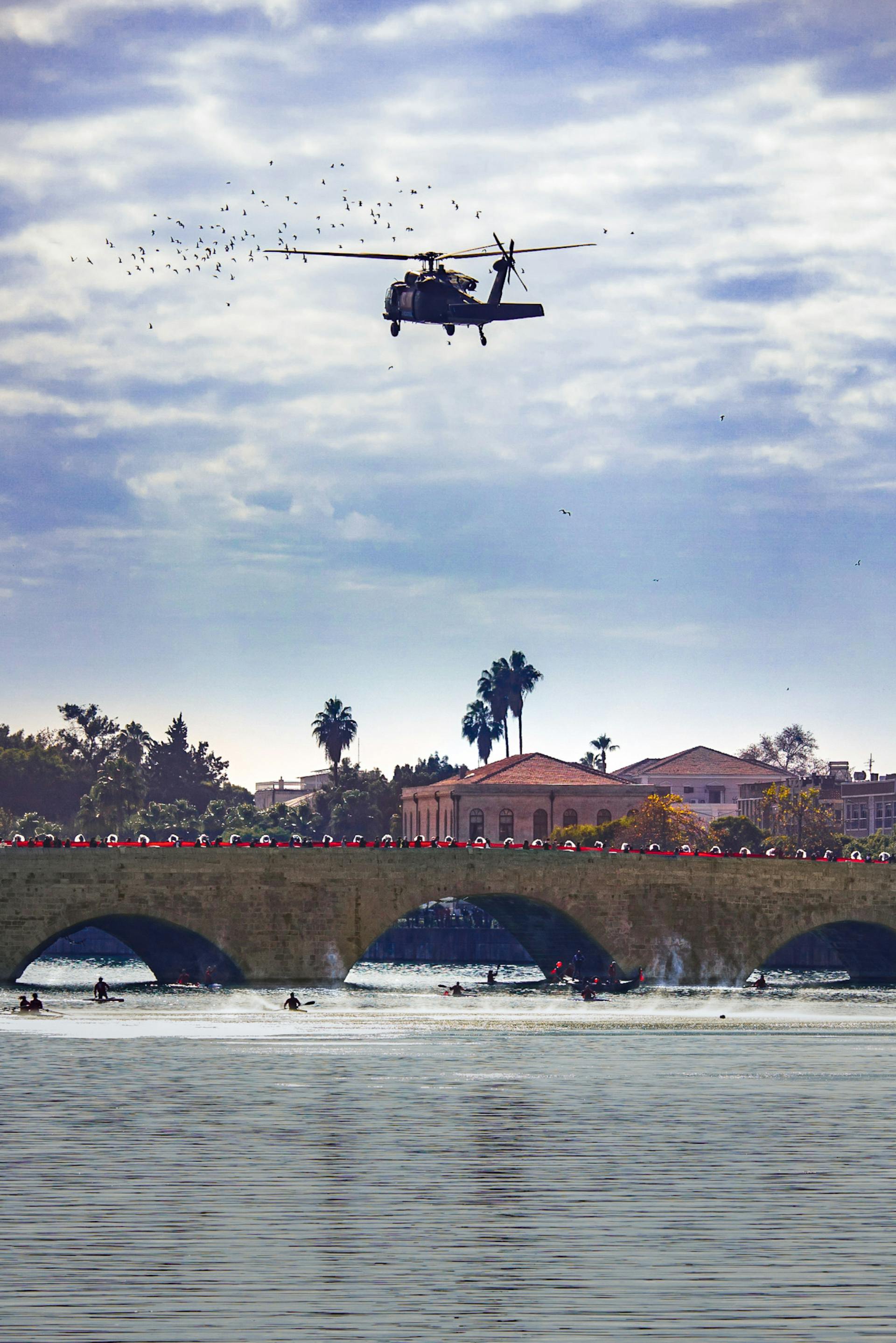 Black Helicopter Flying over Body of Water · Free Stock Photo