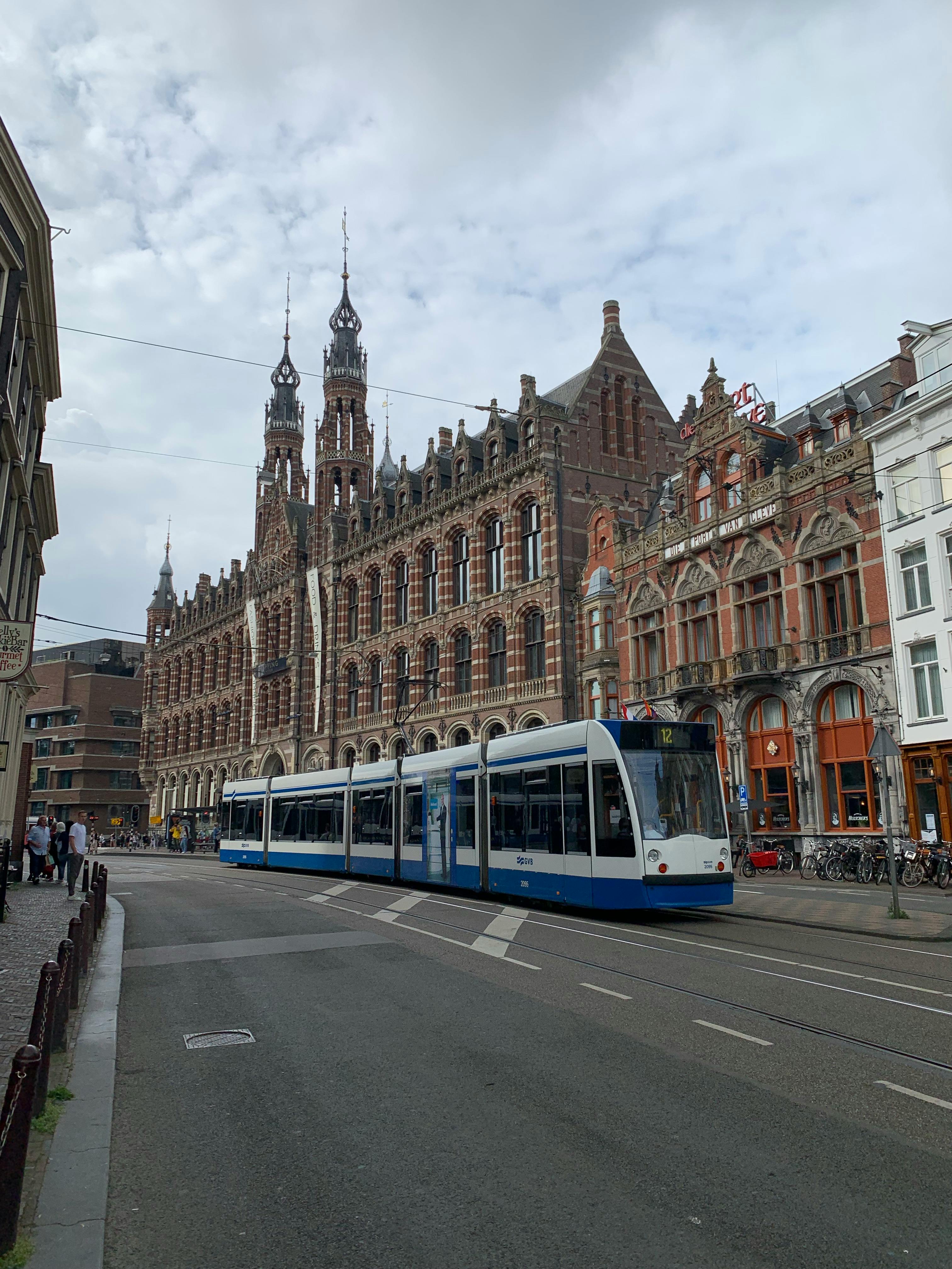 A Tram Passing by the Magna Plaza in Amsterdam · Free Stock Photo