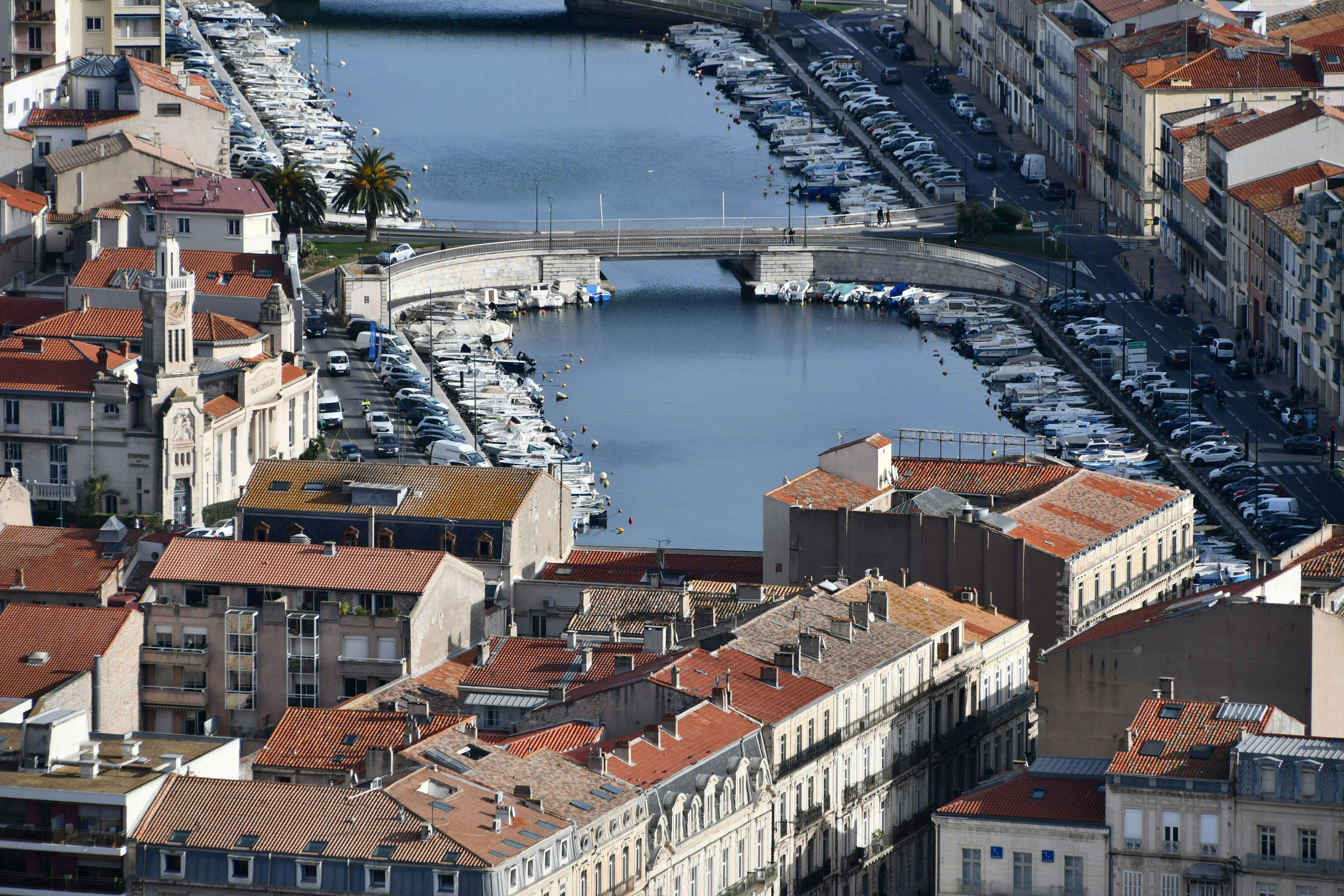 Brown and White Concrete Building near Bridge · Free Stock Photo