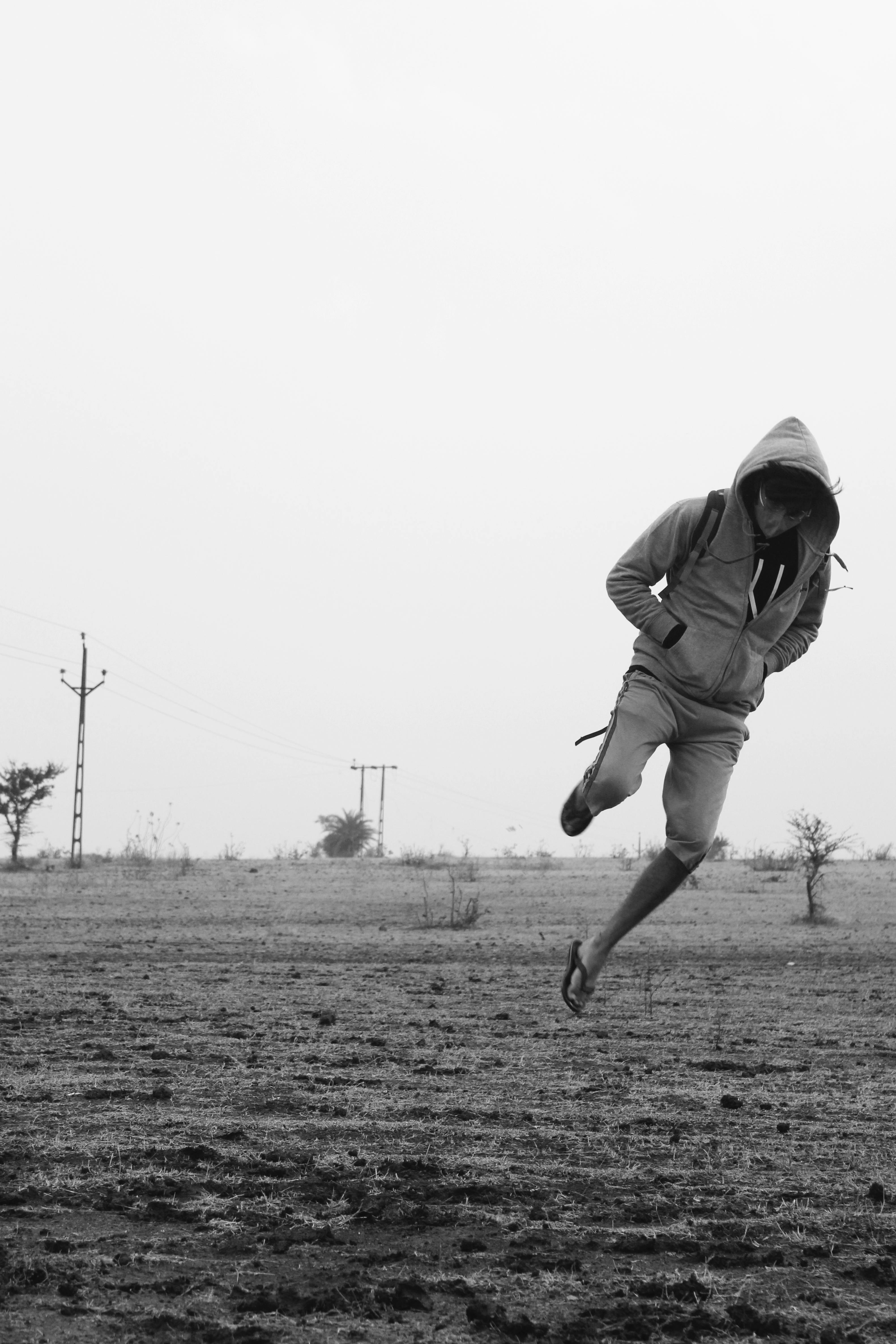 Grayscale Photo Of Person Jumping · Free Stock Photo