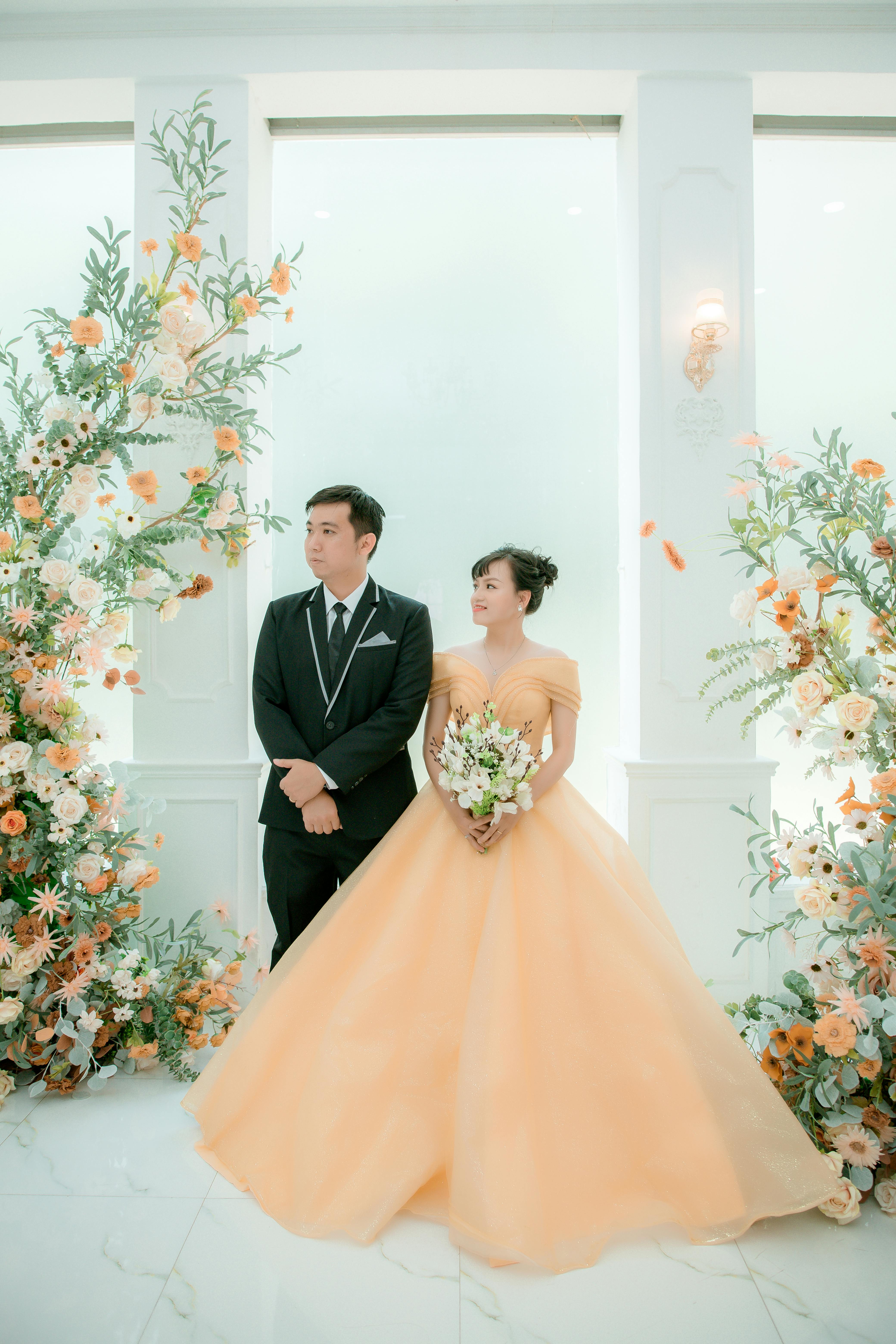 Bride and Groom Standing Next to Each Other while Looking Afar · Free ...