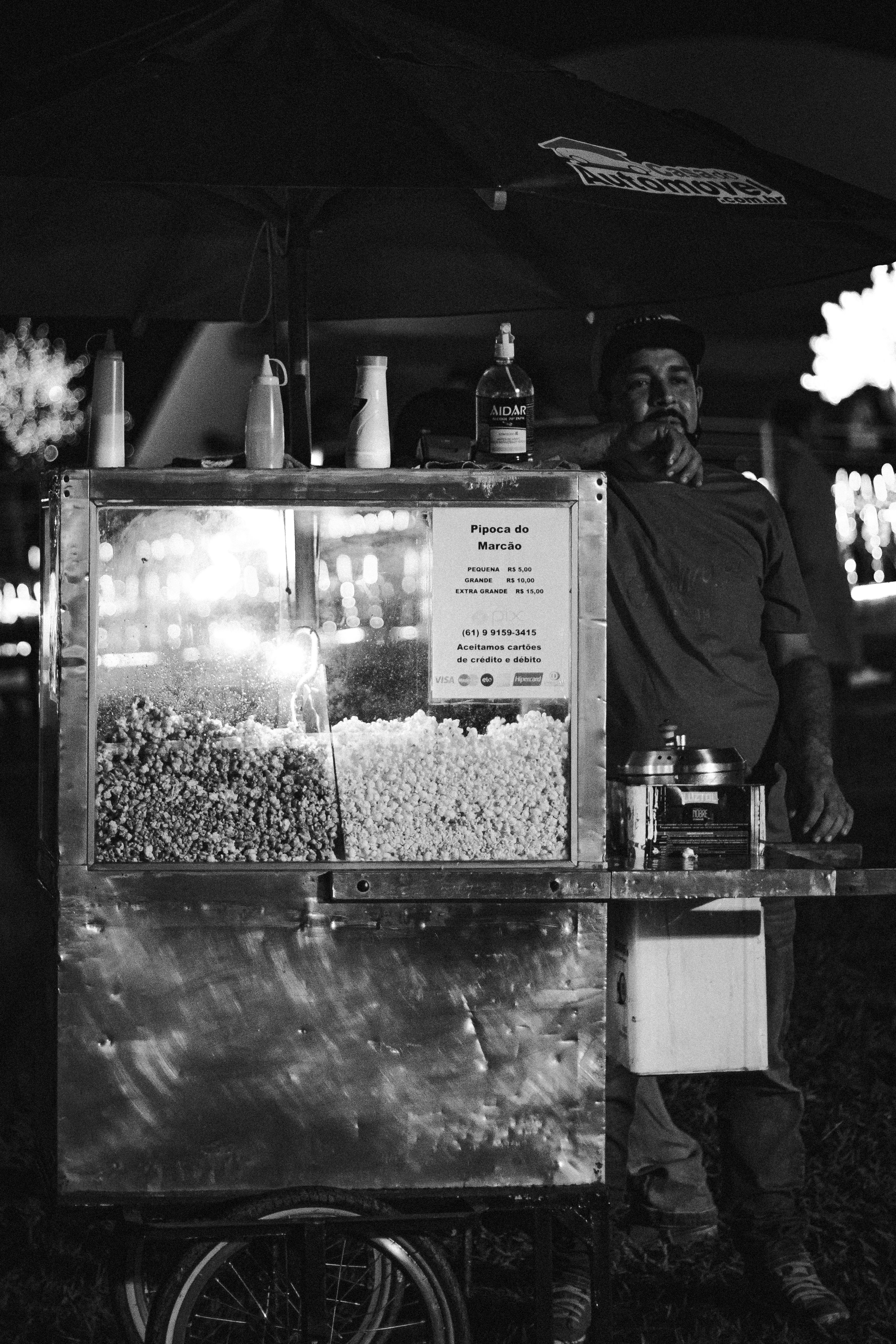 Black and White Shot of a Man Shopping at a Market Stall · Free Stock Photo